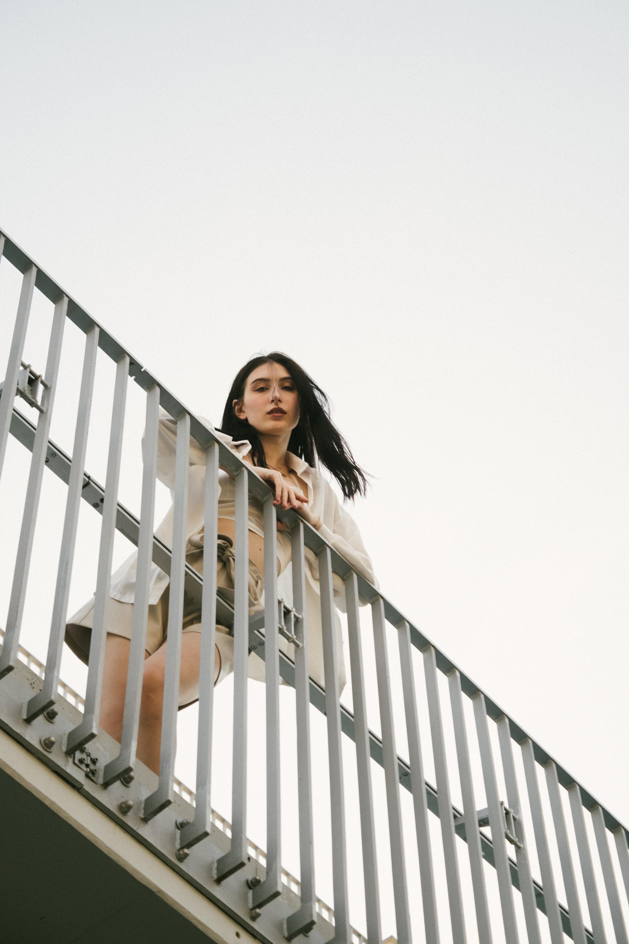 Low Angle Shot of a Woman on Metal Railings · Free Stock Photo