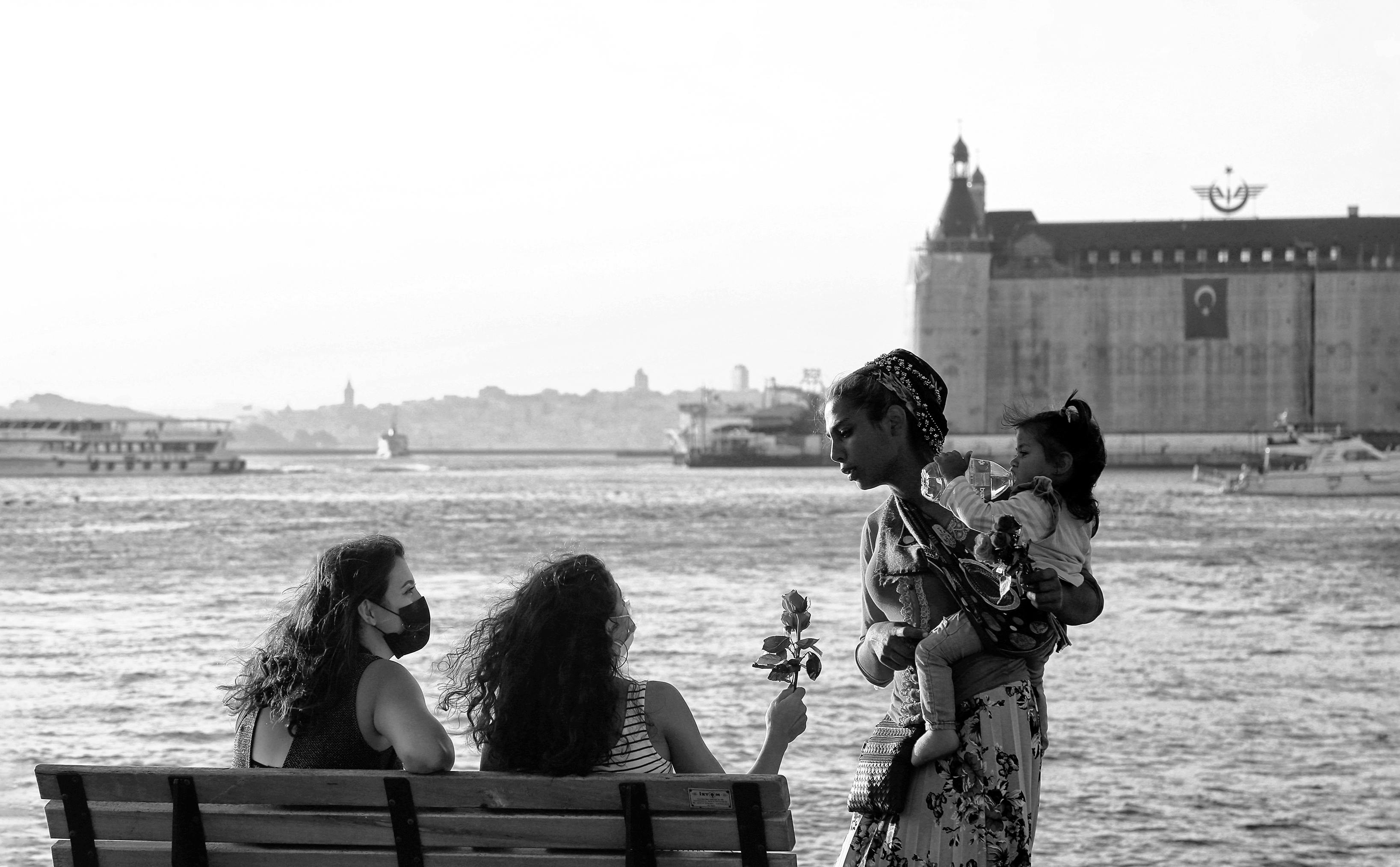 Women with Child Sitting on Bench near Water · Free Stock Photo
