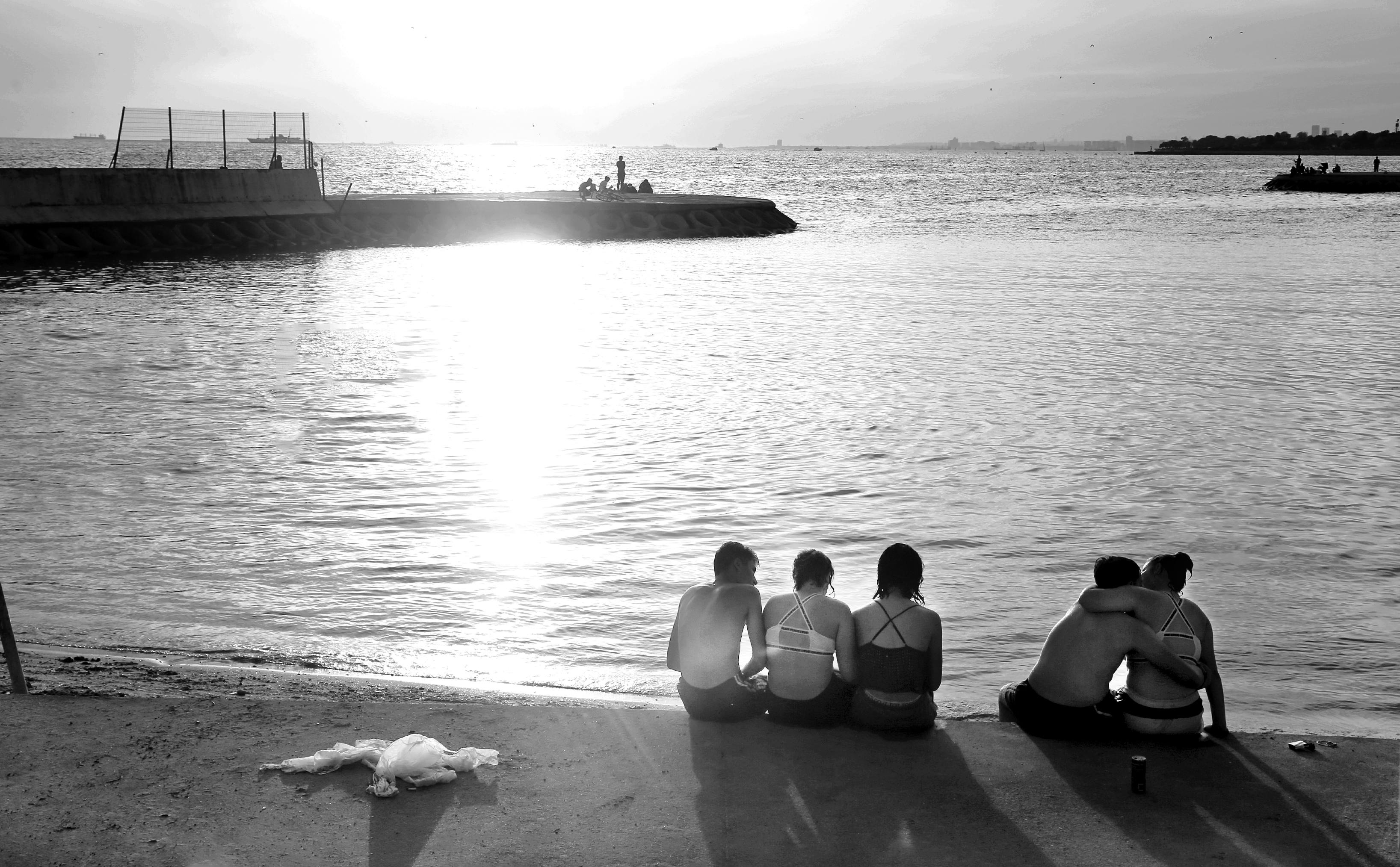People Sitting on the Beach During Sunset · Free Stock Photo