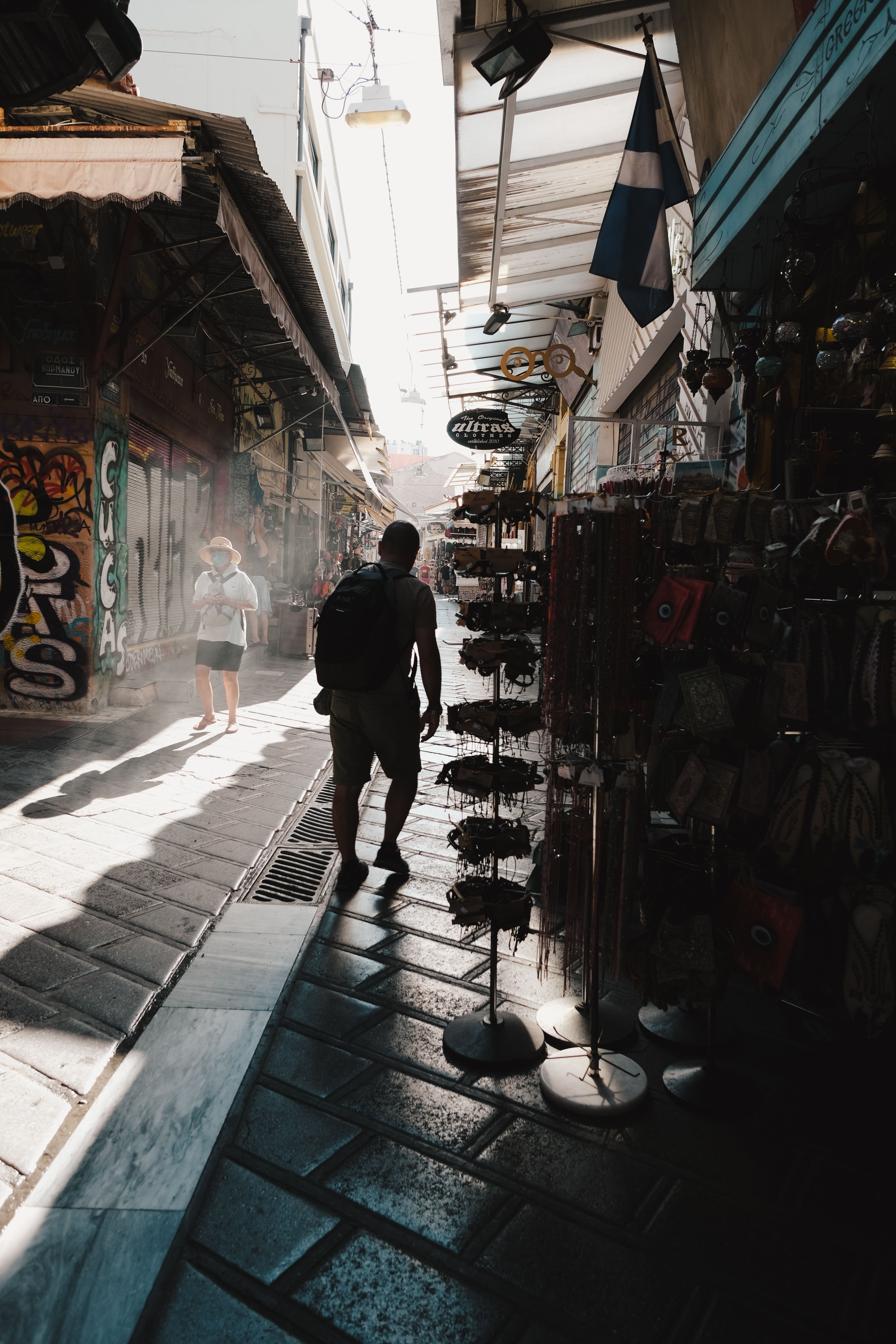 People Walking on the Street in between Buildings · Free Stock Photo