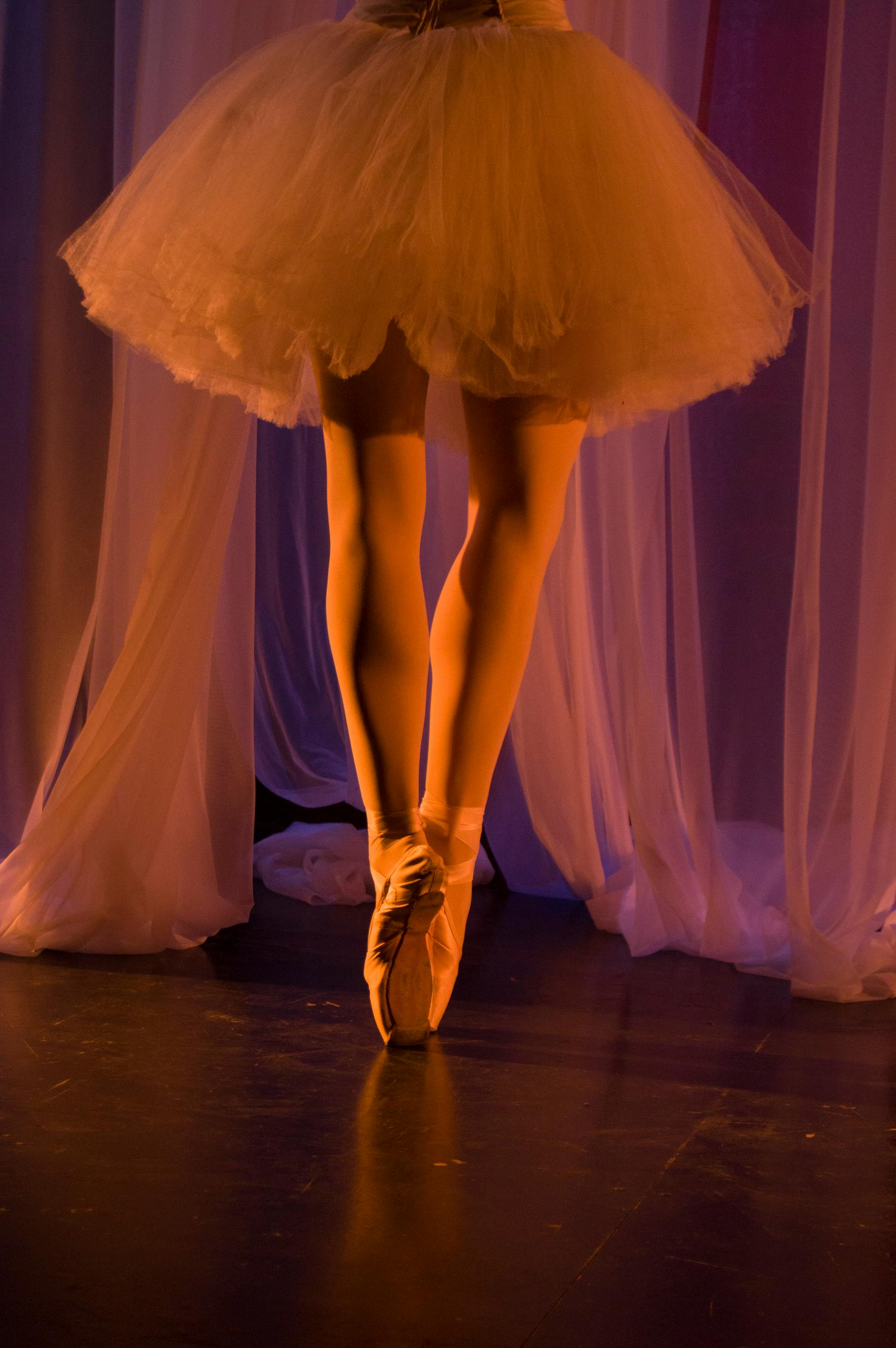 Back View of a Ballerina Sitting on a Curb · Free Stock Photo