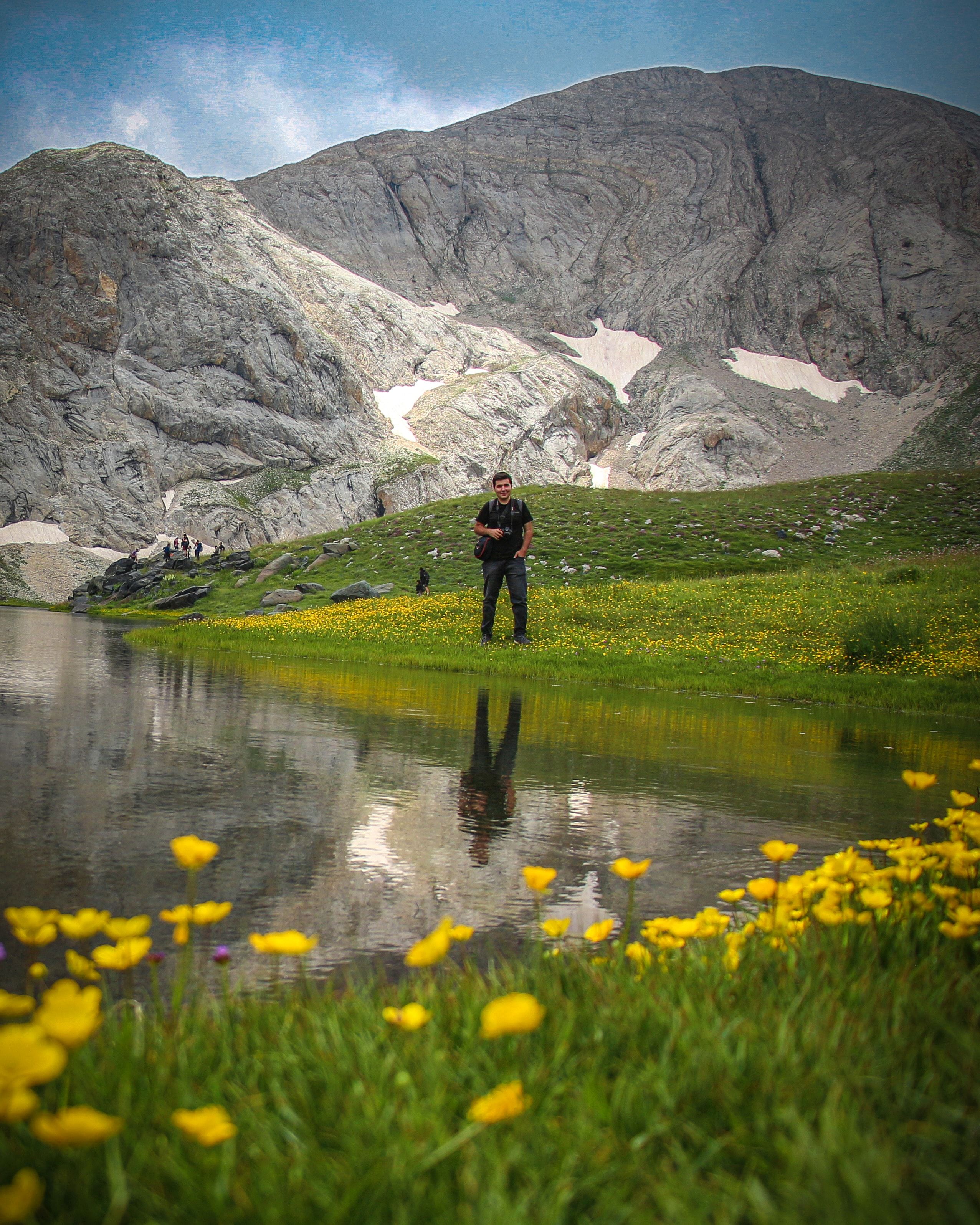 Man Waling Beside a Lake · Free Stock Photo