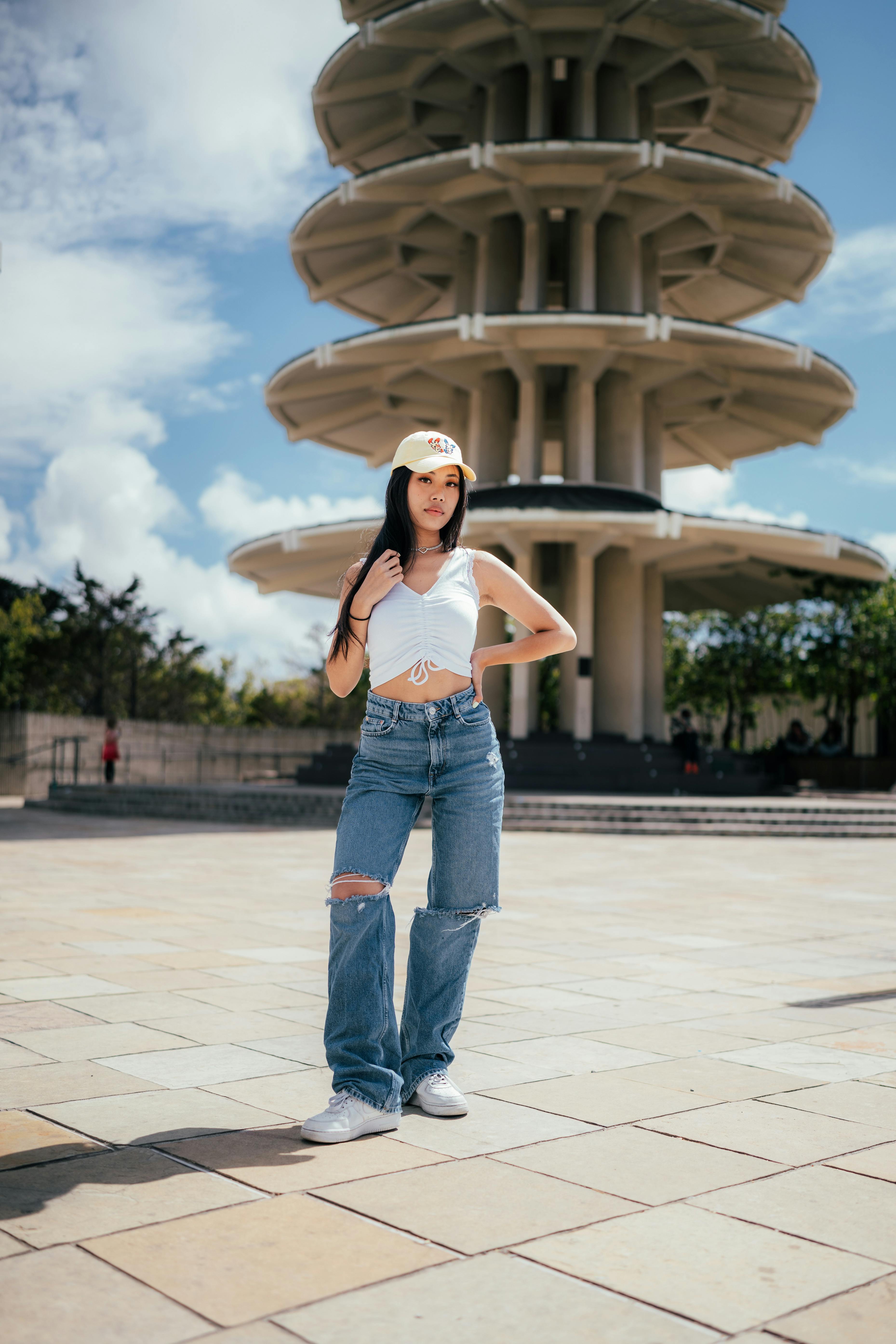Photograph of a Woman with a Cap Posing with Her Hand on Her Waist ...