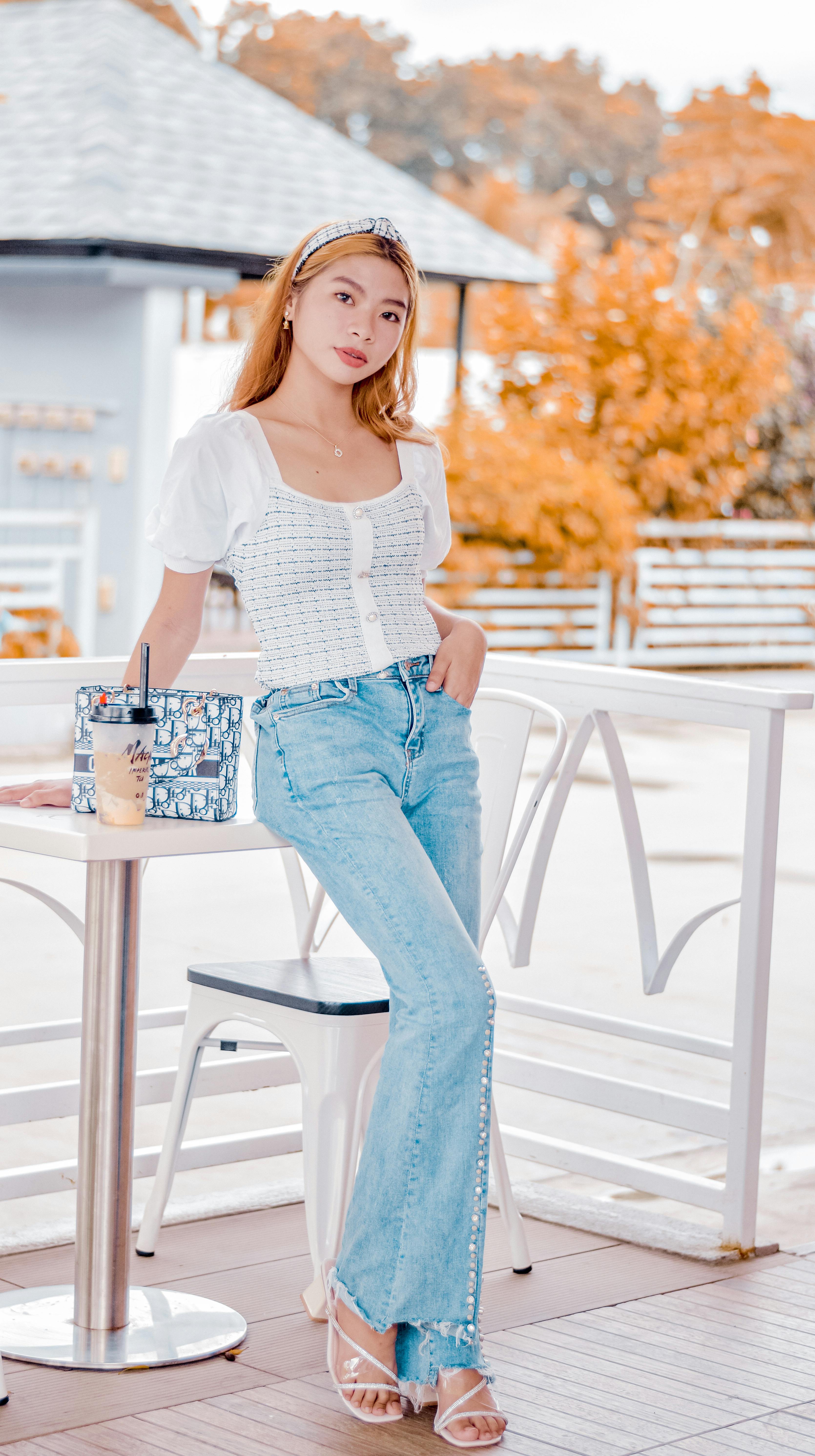 Woman in White Blouse Leaning Back on a Coffee Table · Free Stock Photo