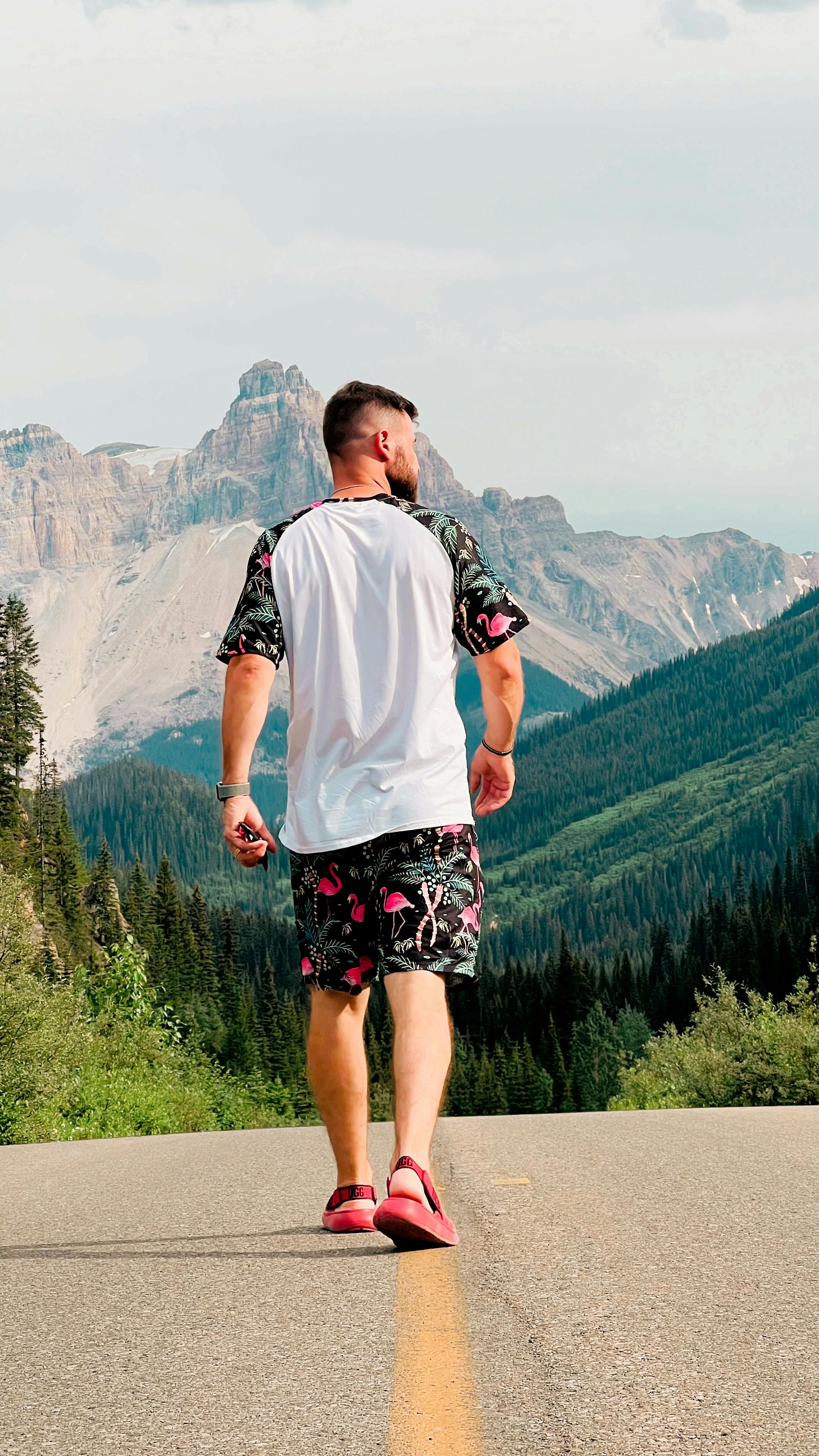 Back View of Man Walking along Road · Free Stock Photo