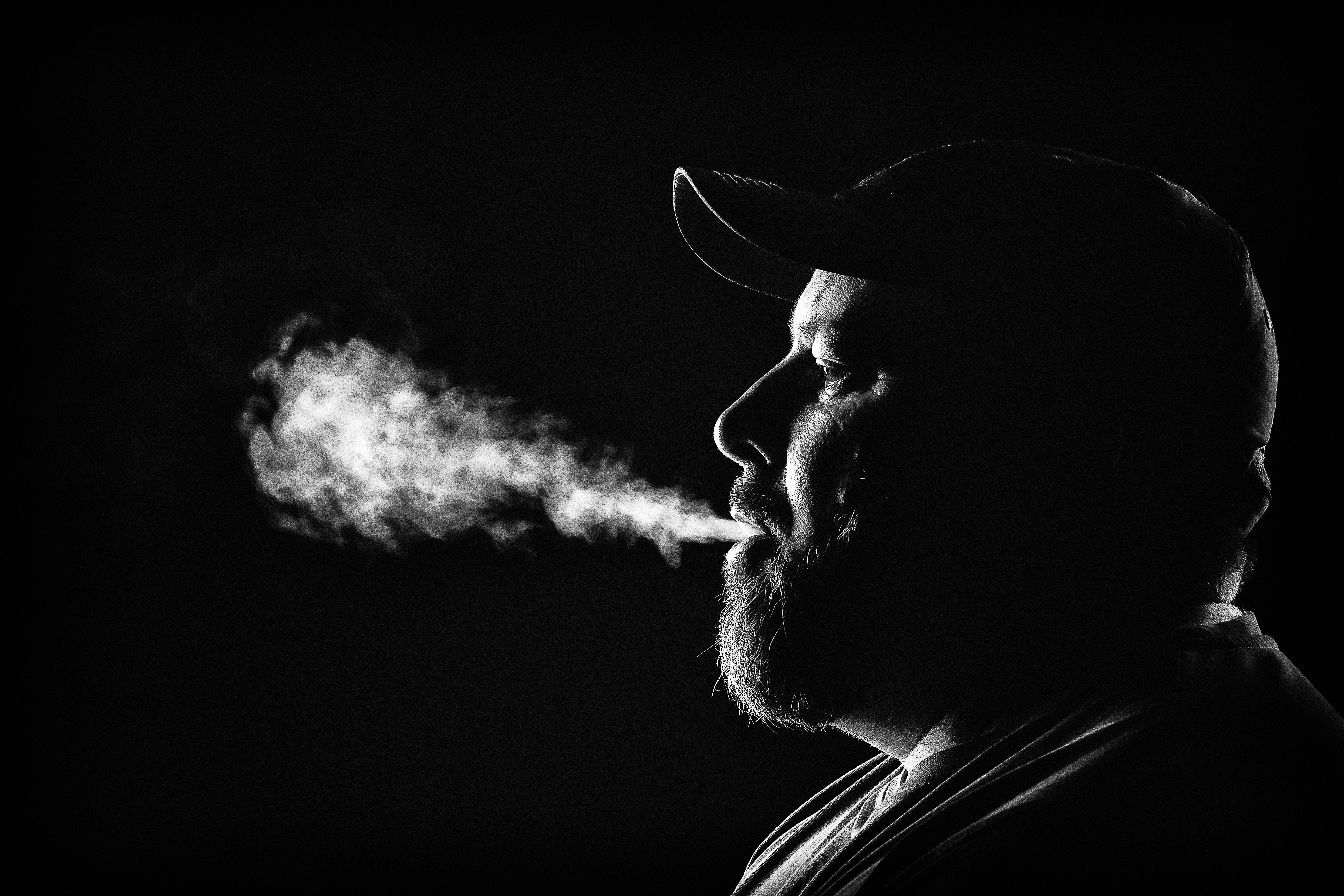 Grayscale Photo of a Man Smoking · Free Stock Photo