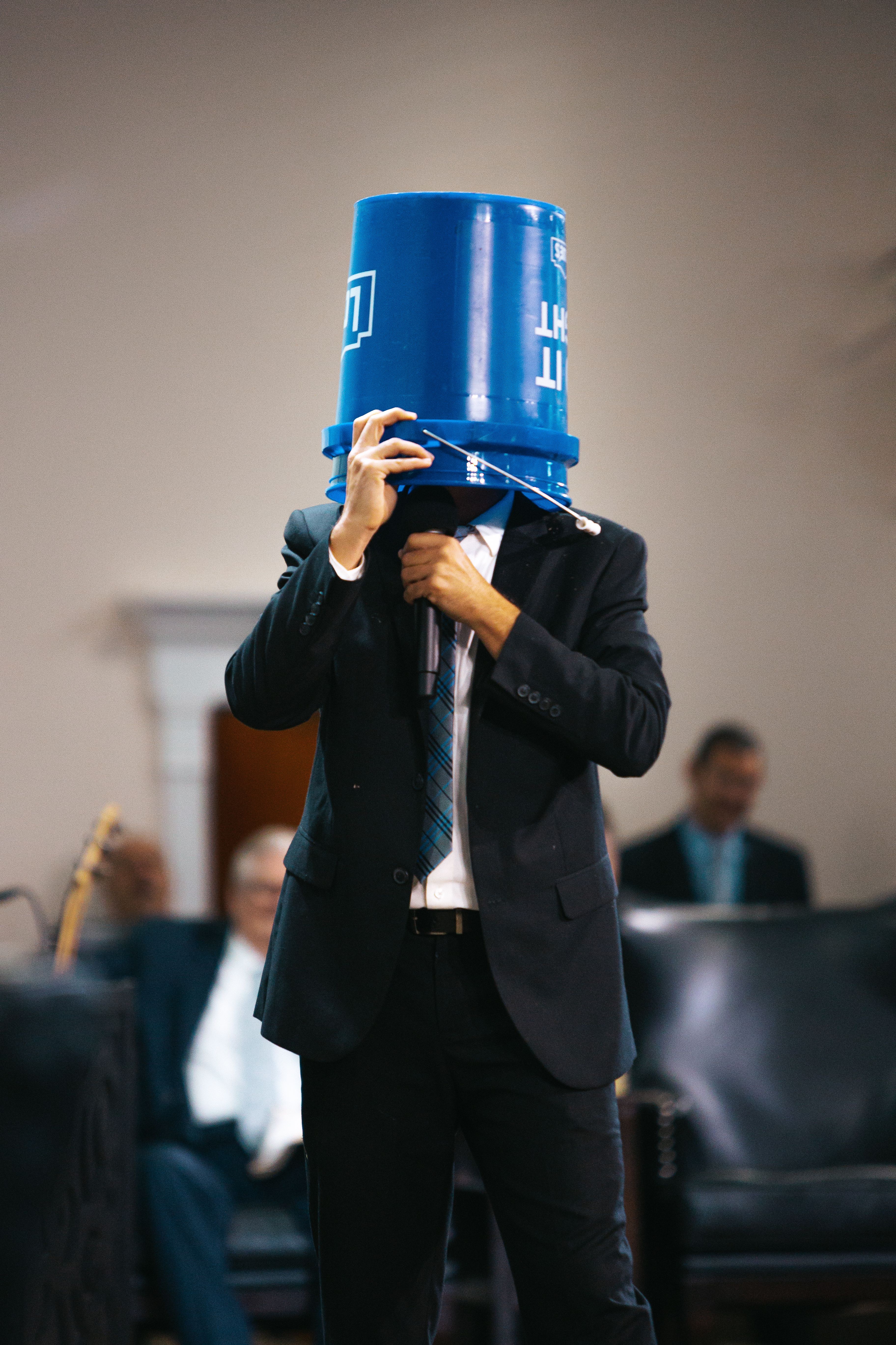 A Person Black Blacker Covering Face with Blue Bucket · Free Stock Photo