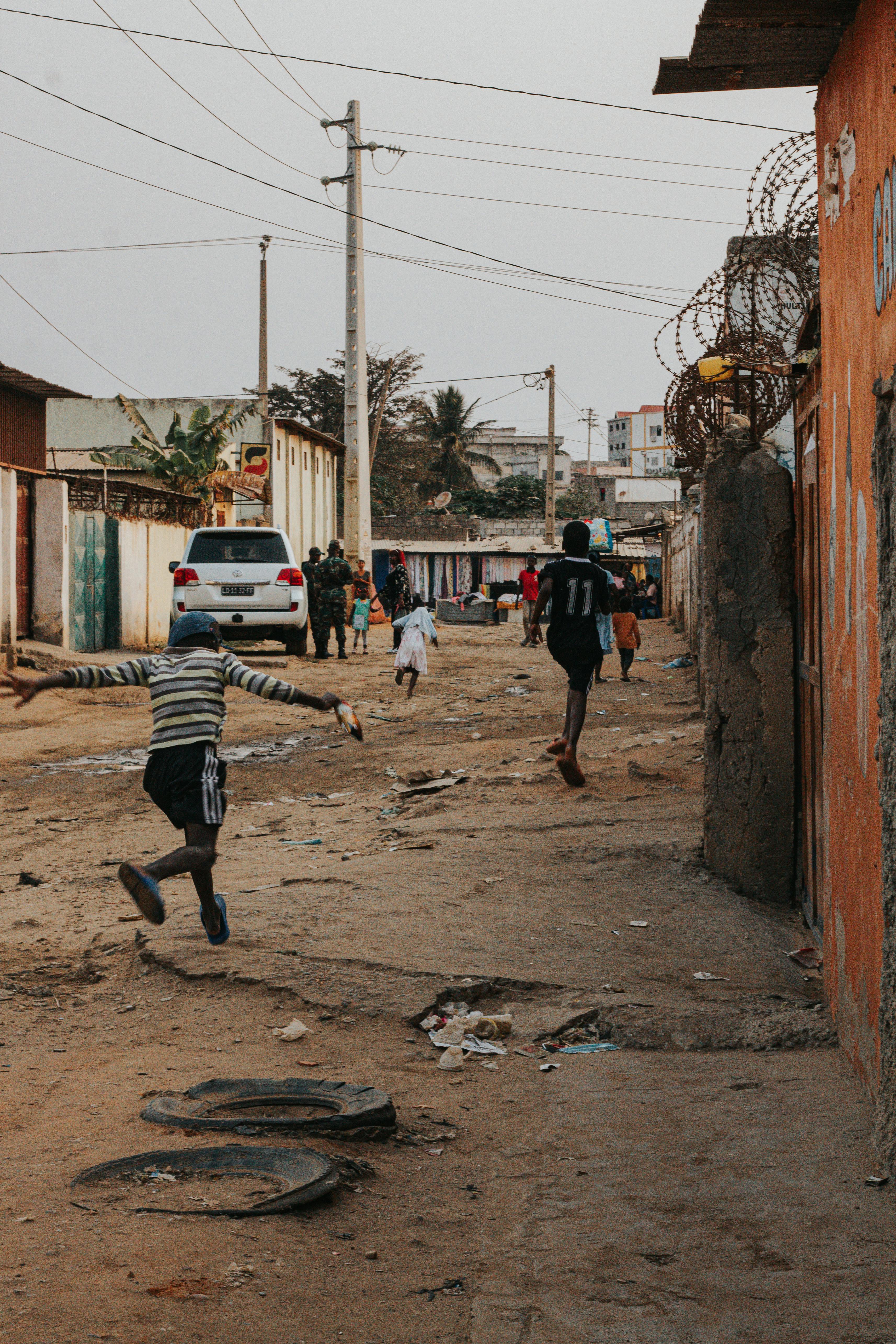 Children Running on an Unpaved Street · Free Stock Photo