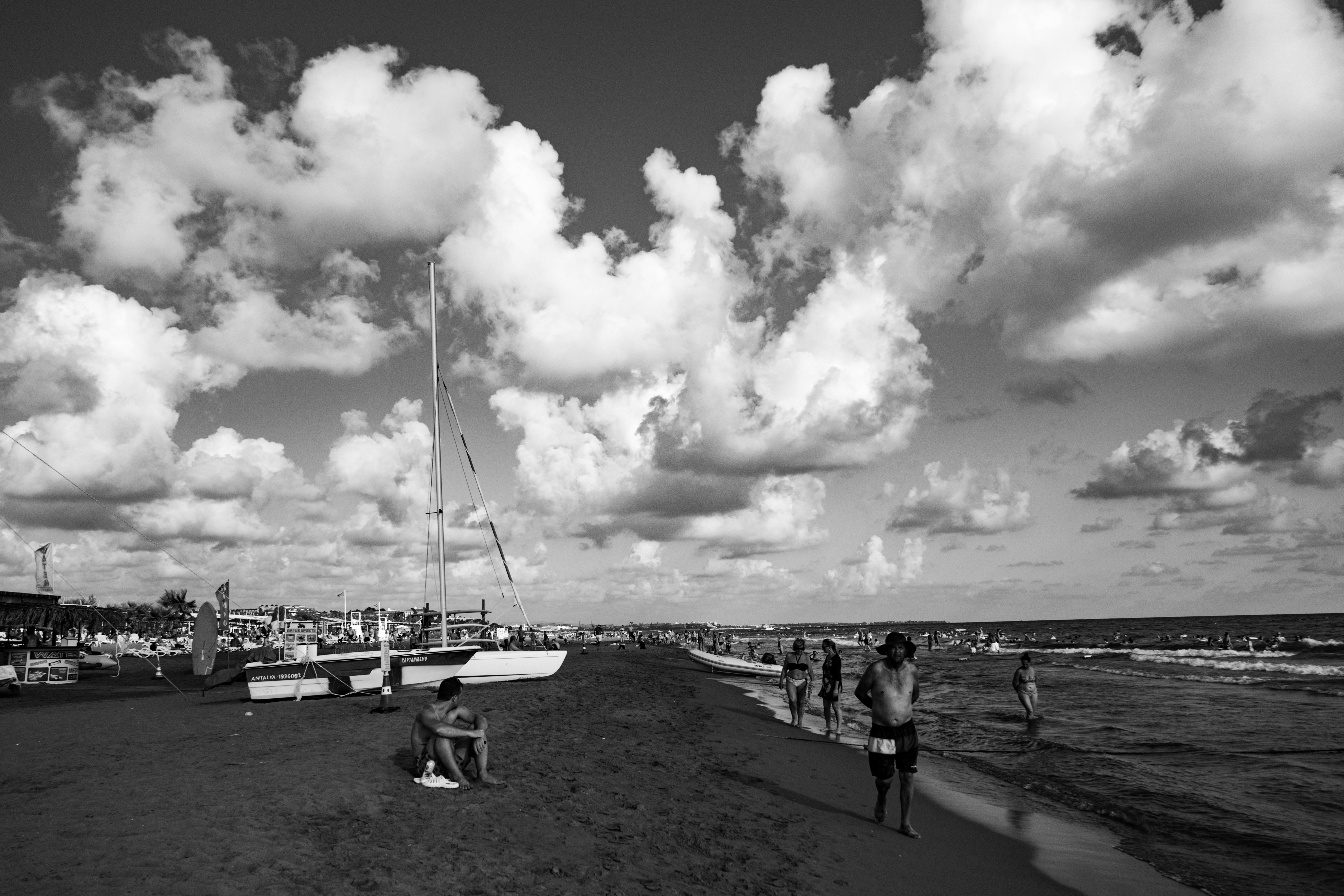 Grayscale Photo of People on Beach · Free Stock Photo