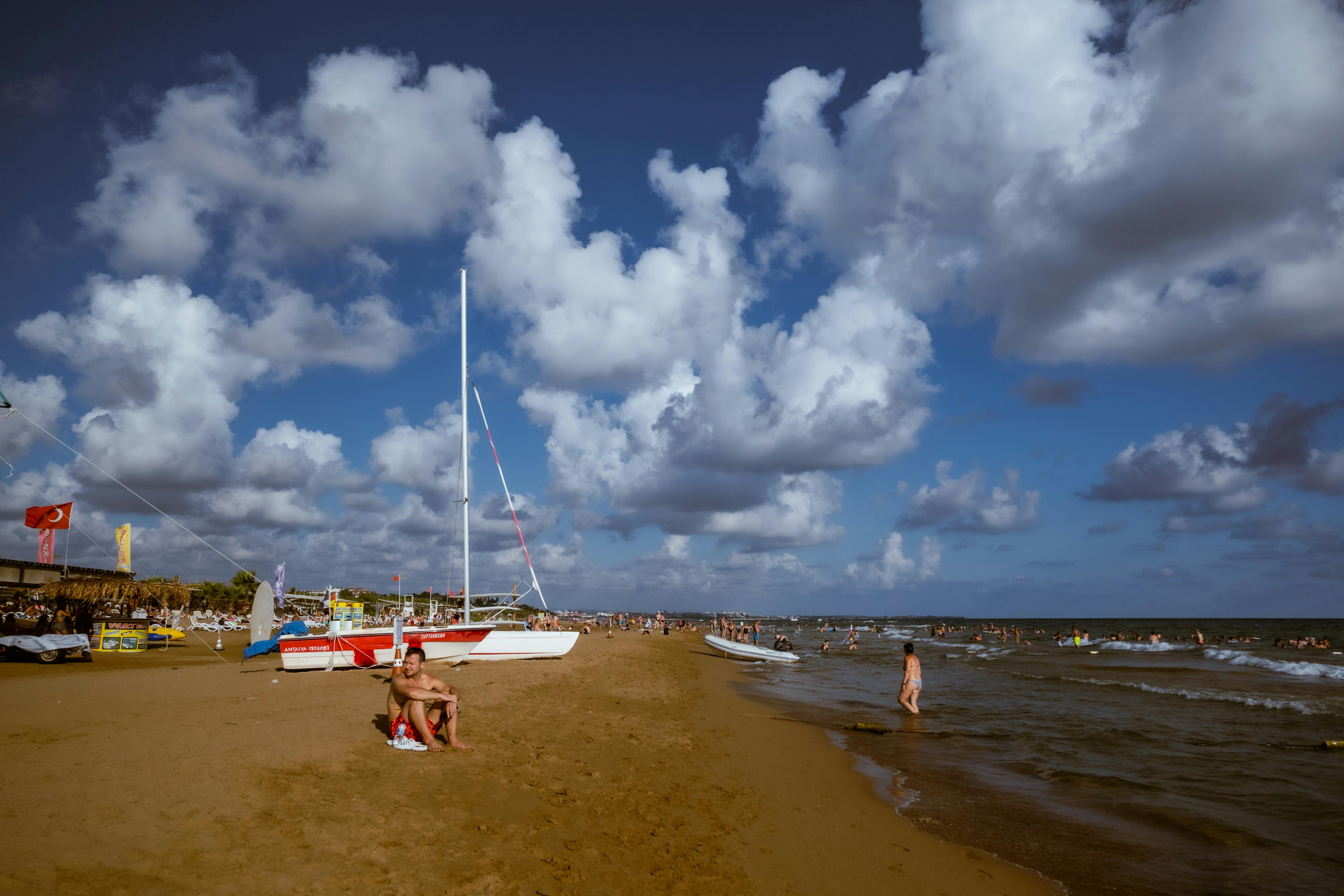 People on the Beach Under the Cloudy Sky · Free Stock Photo