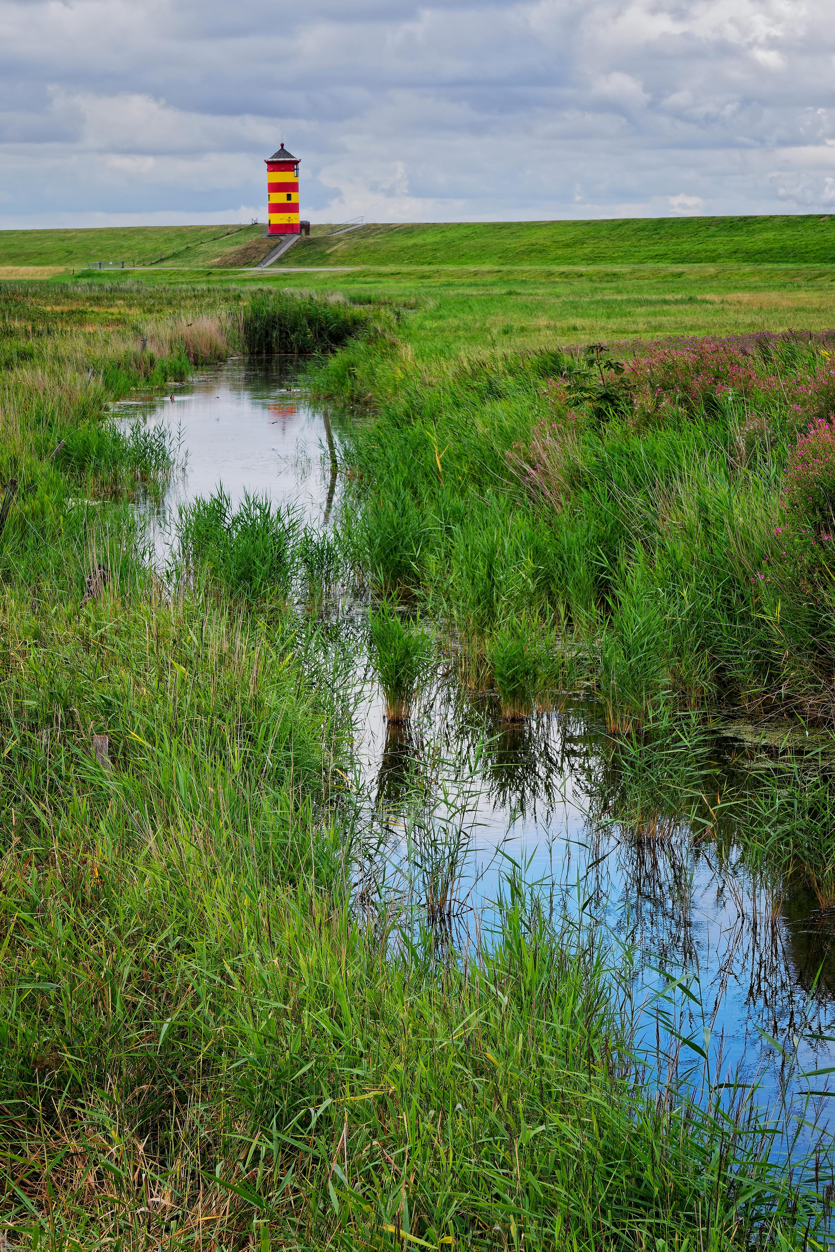 A Lighthouse on Green Grass Field · Free Stock Photo