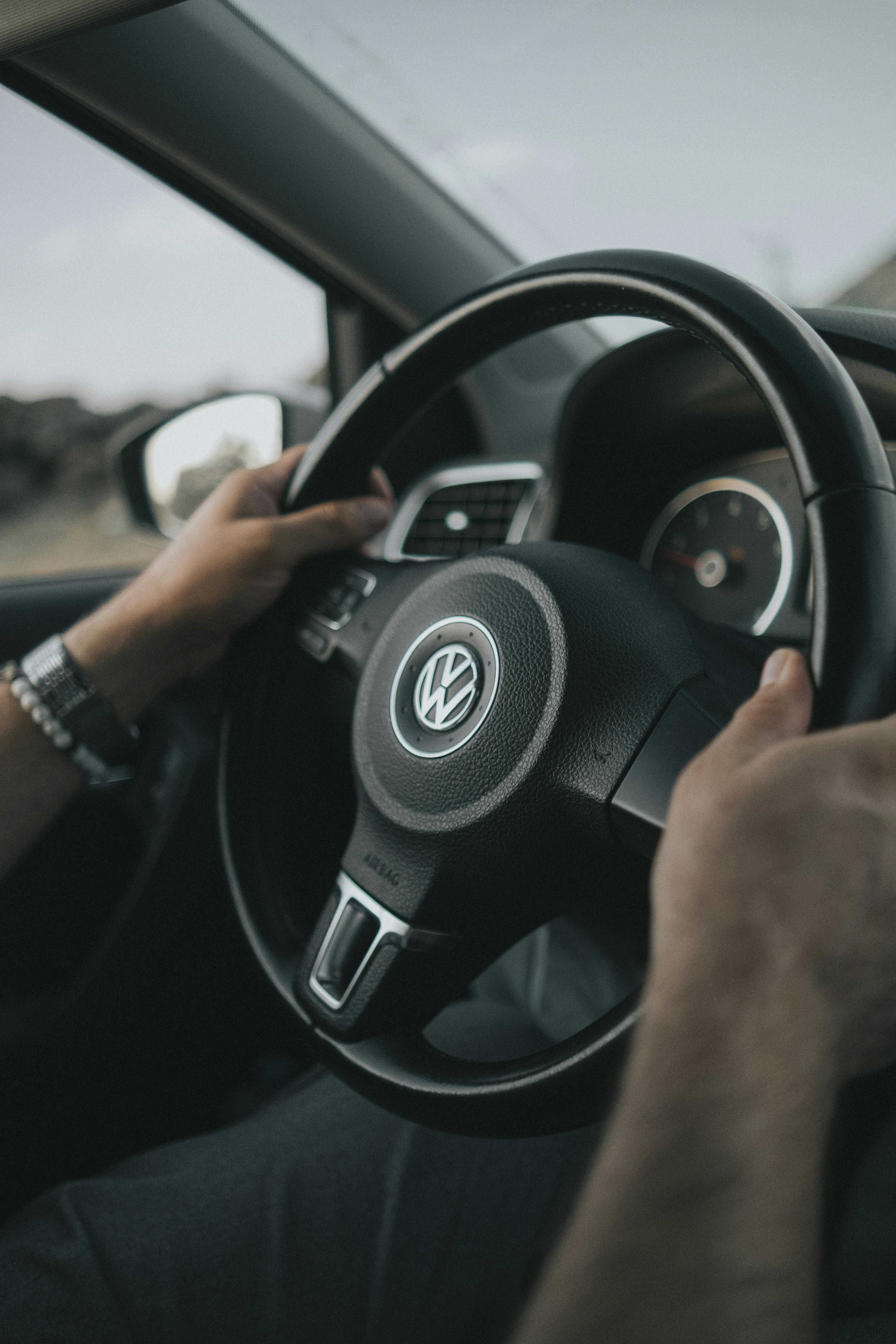 Person Holding a Steering Wheel · Free Stock Photo