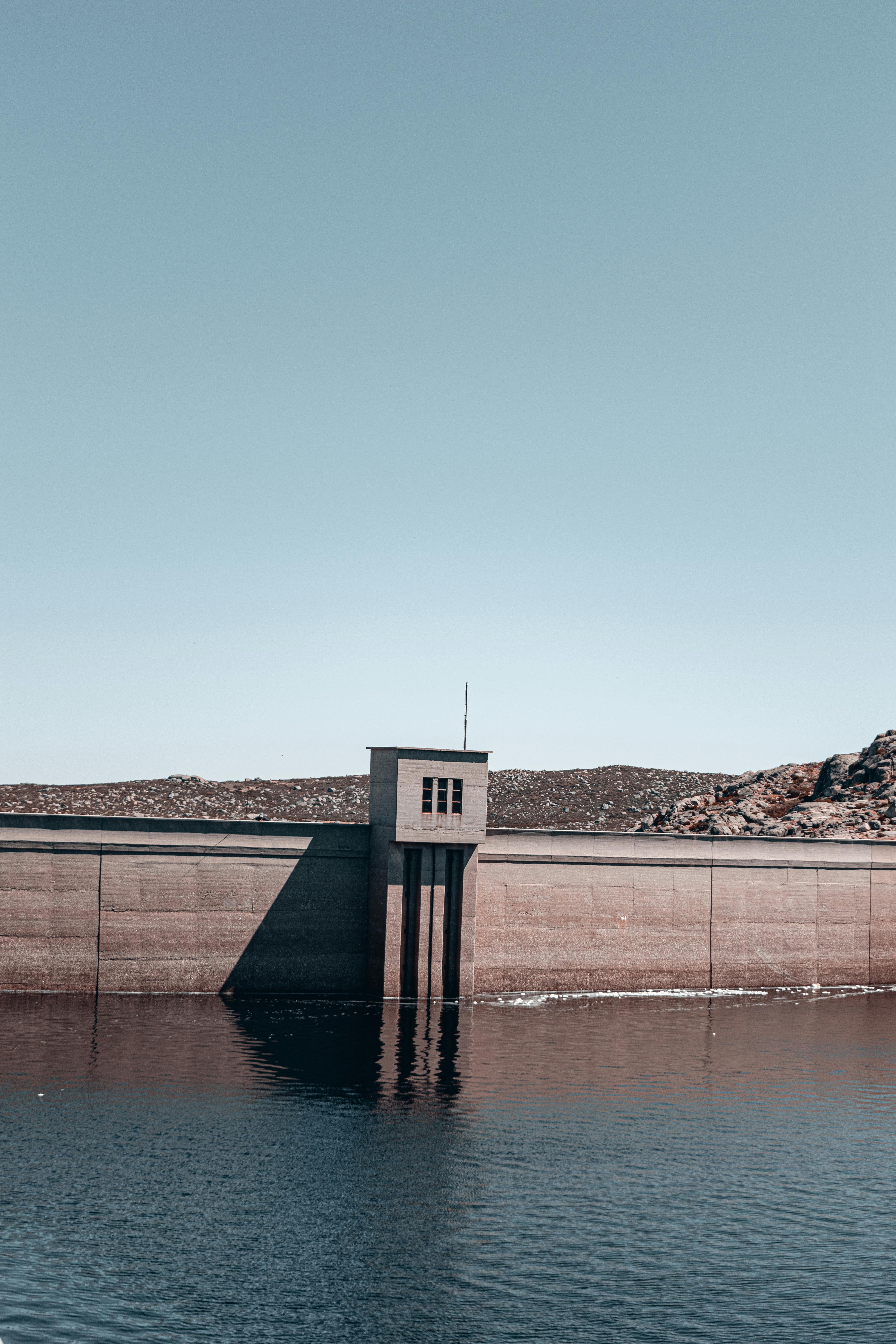 View of a Water Dam on a Reservoir in Hills · Free Stock Photo