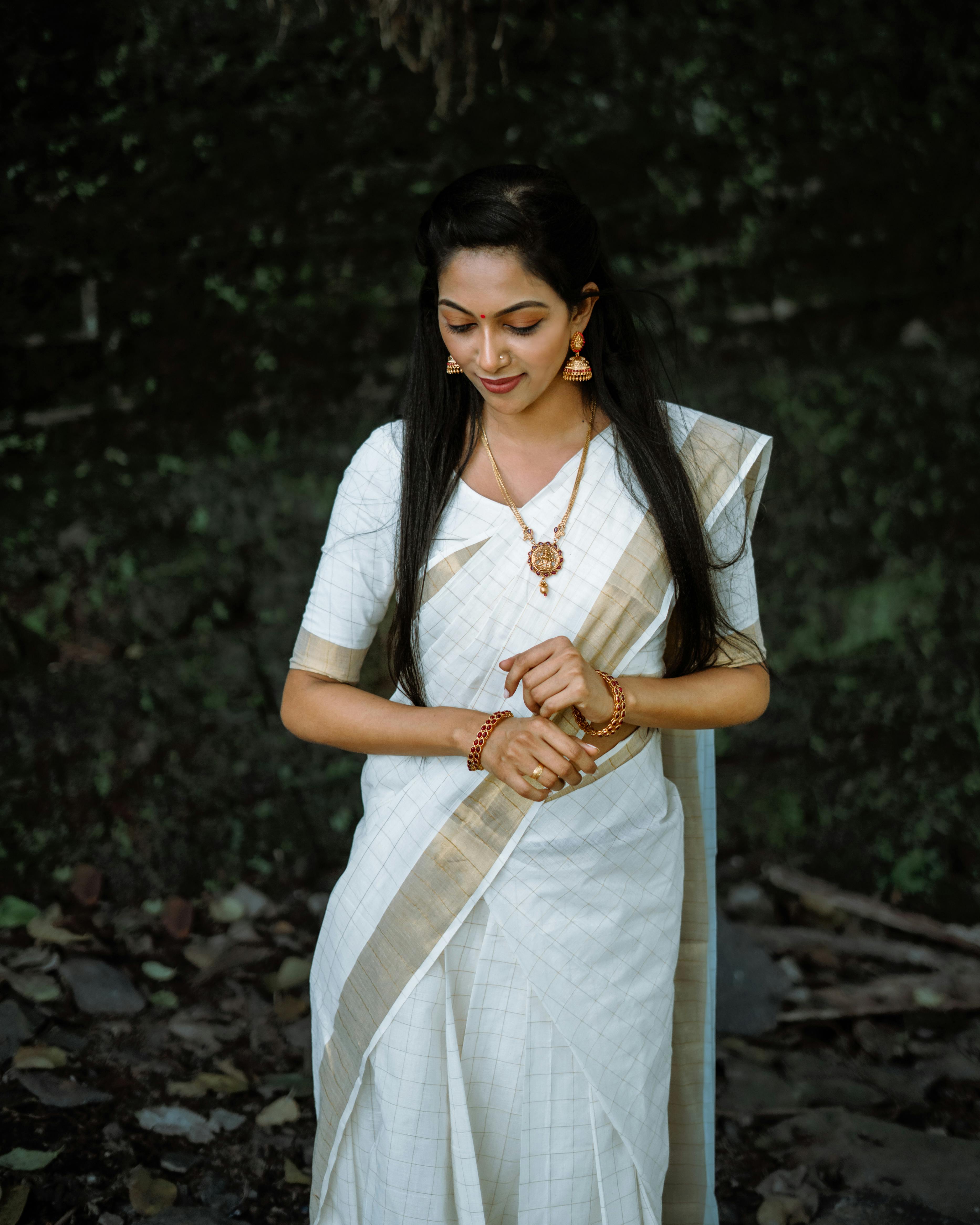 Brunette Woman in Peach Saree Sitting on Steps · Free Stock Photo
