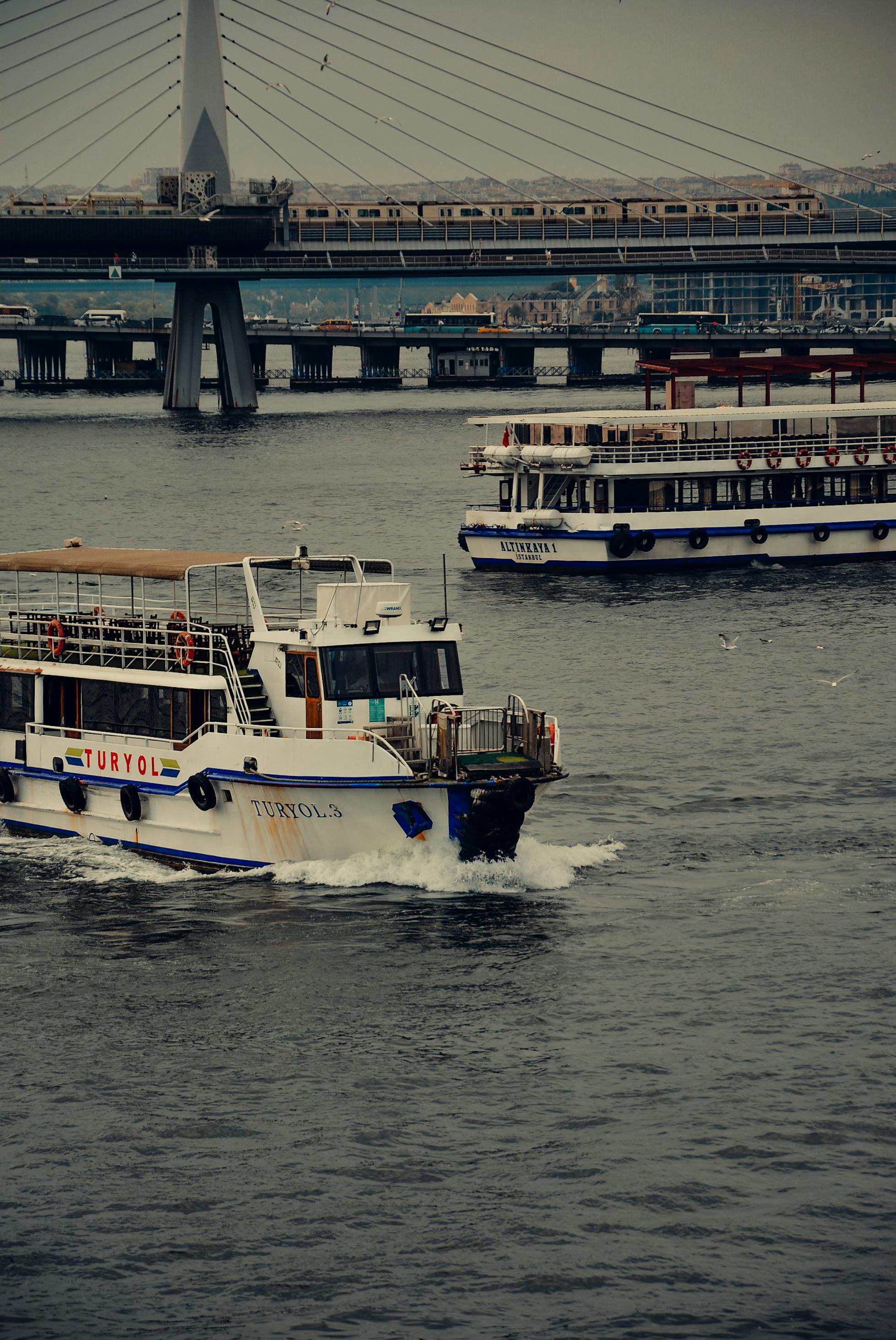 Ferry Boats on Body of Water Near Bridge · Free Stock Photo