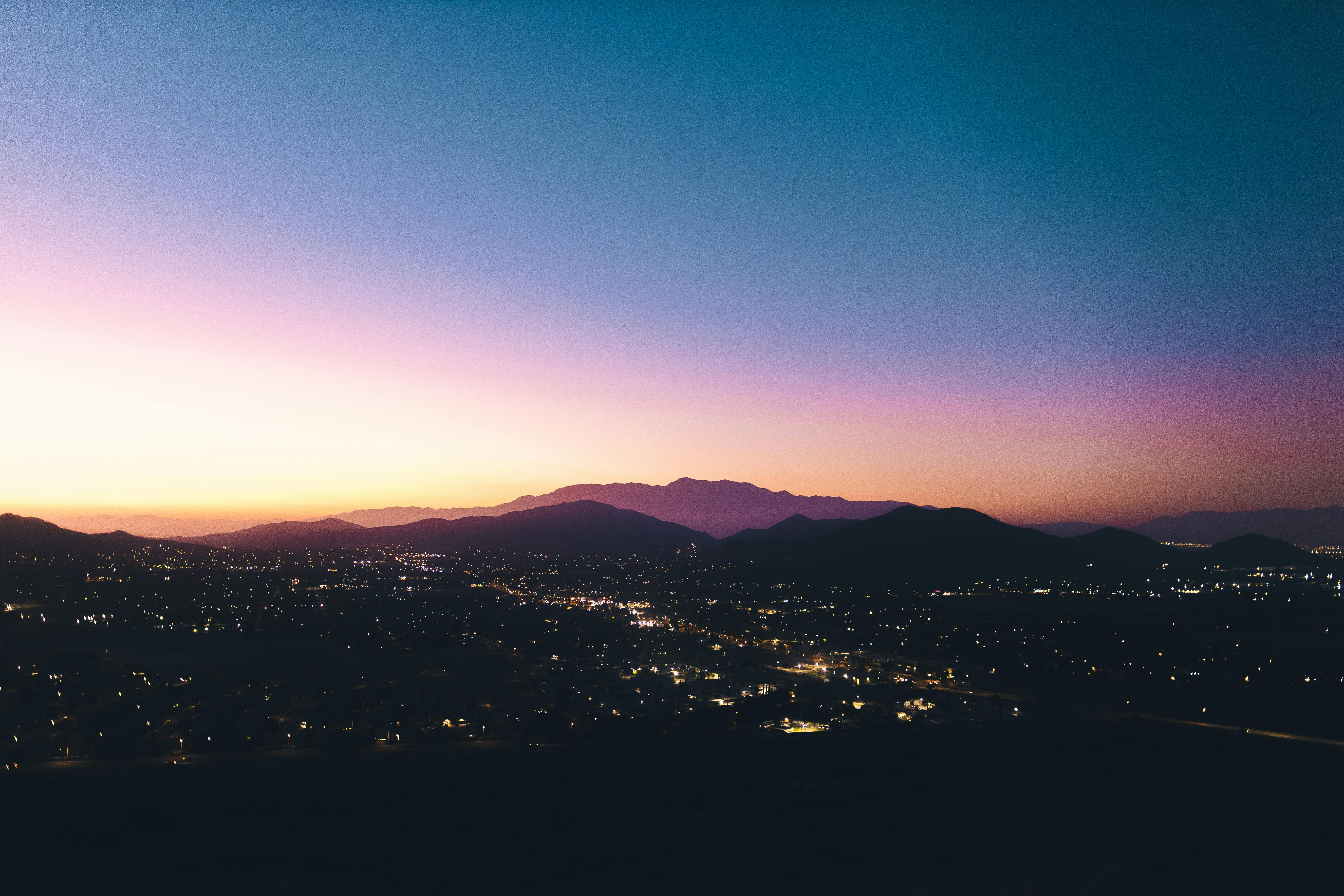 Mountains and City Lights at Dusk · Free Stock Photo