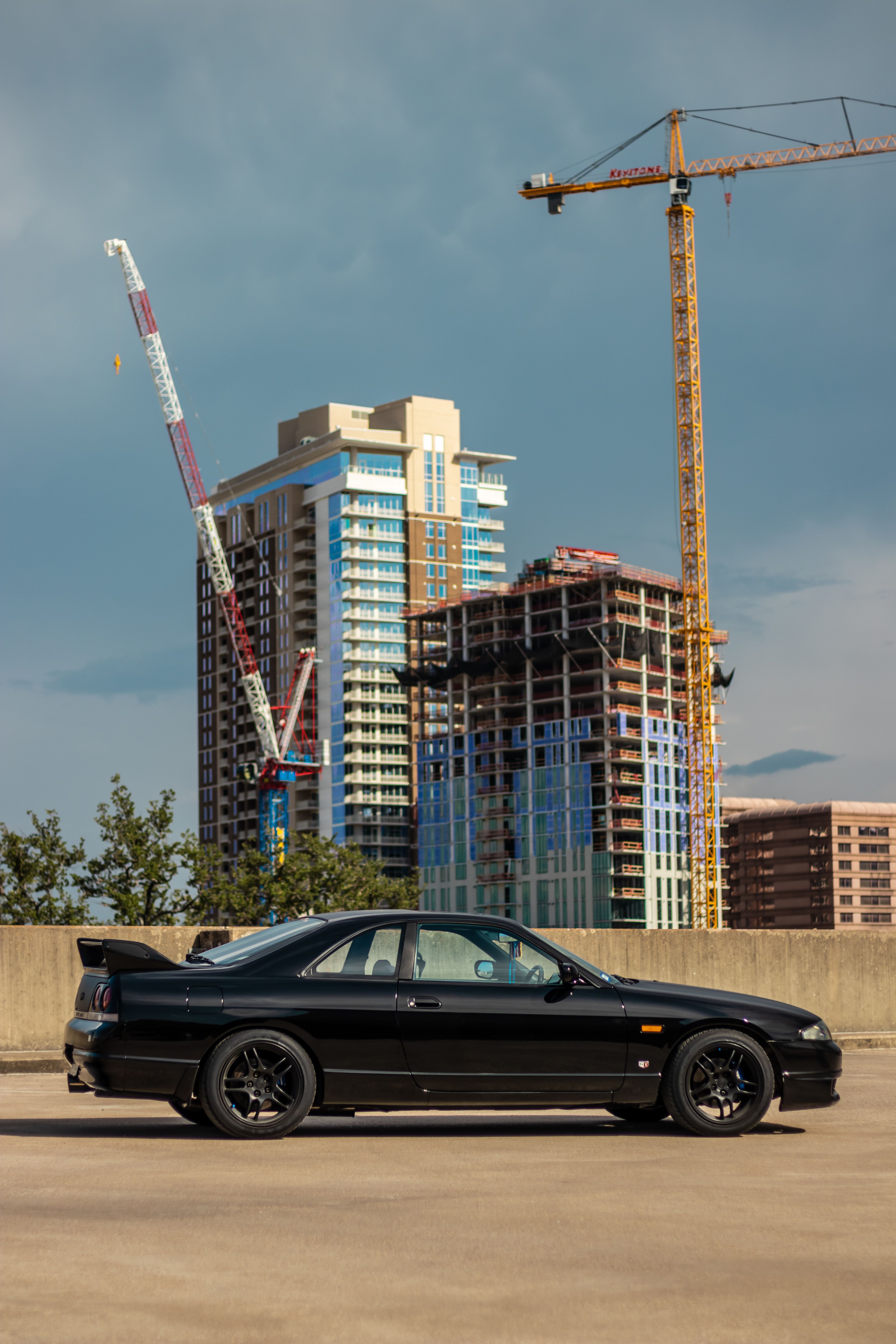 Black Car on Concrete Pavement Near Under Construction Building · Free ...