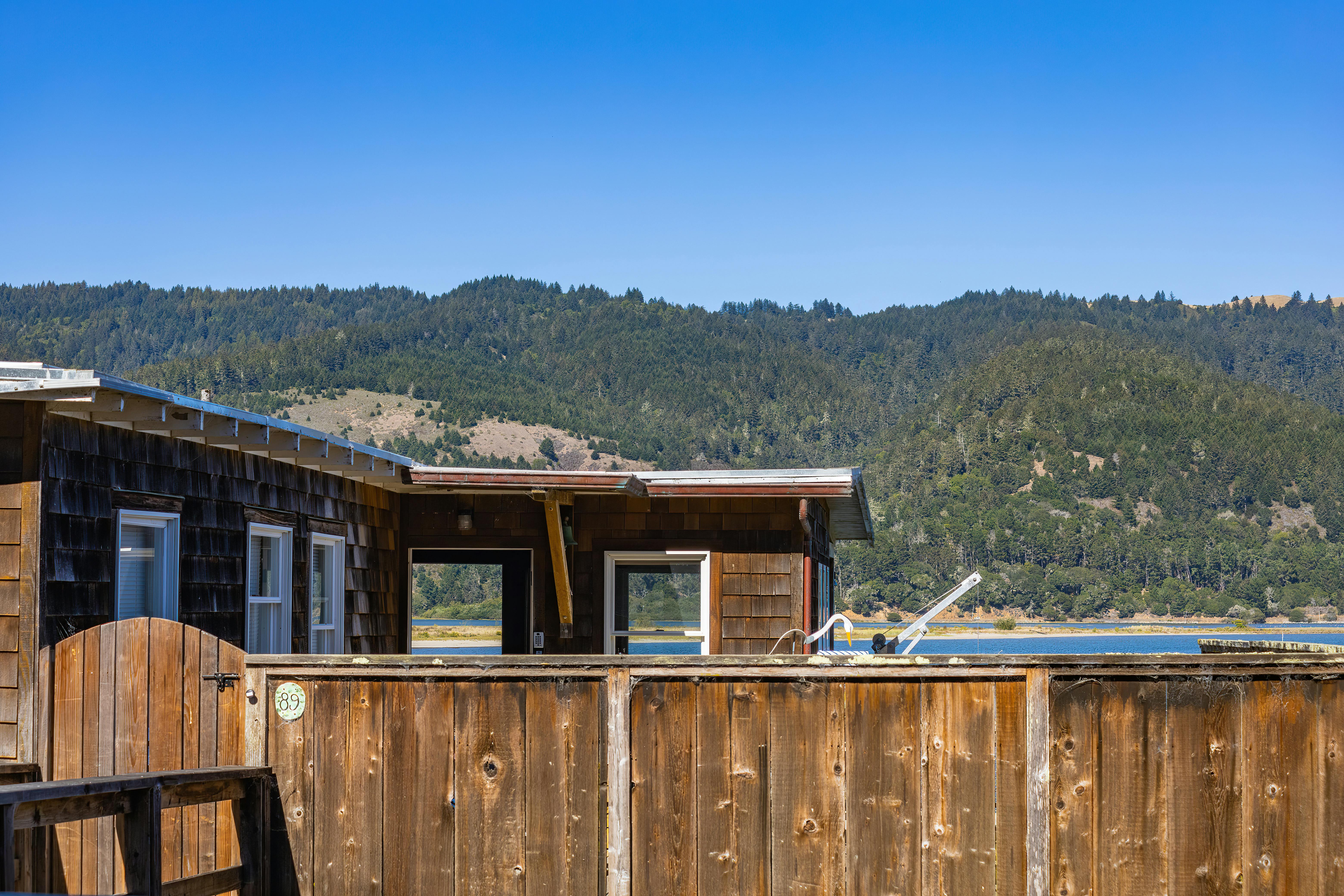 Wooden House Near Body of Water · Free Stock Photo