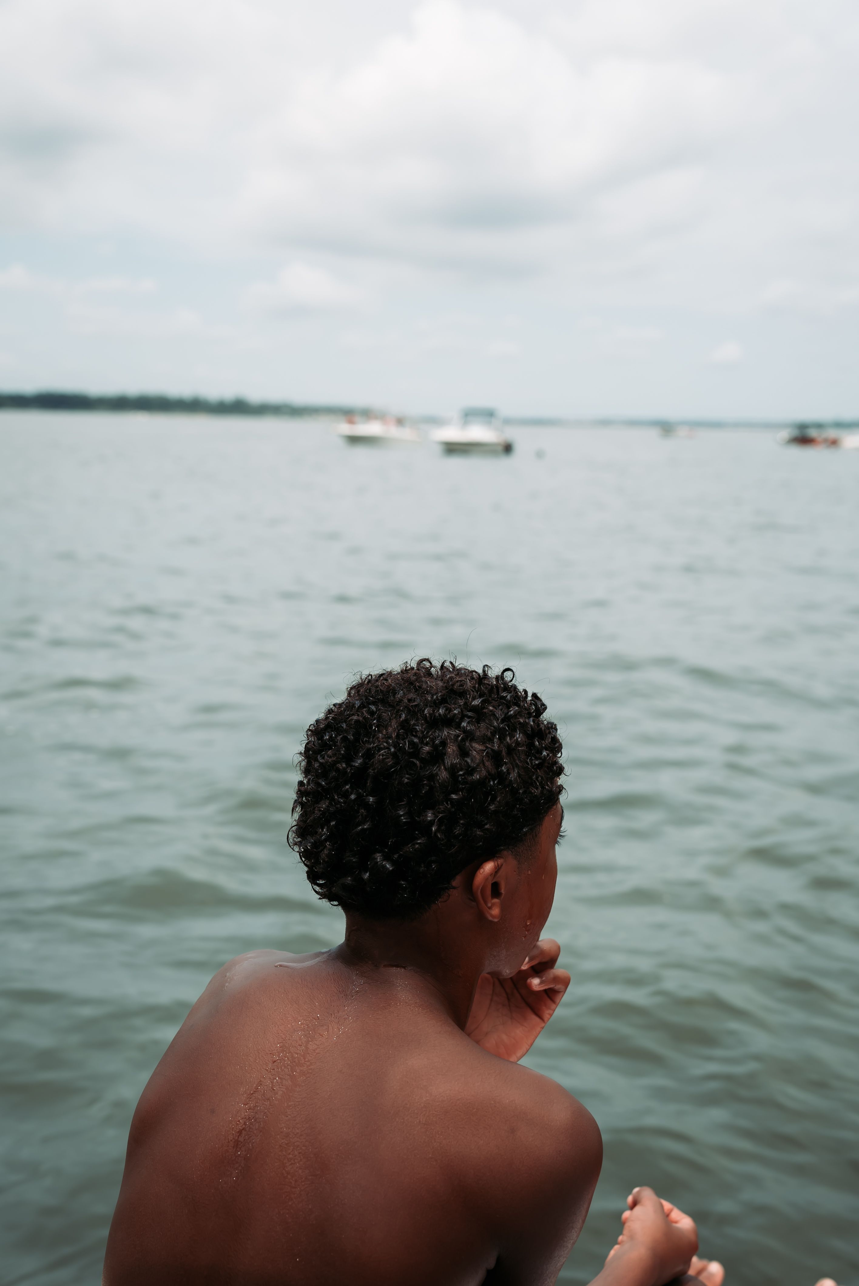Boy Sitting Beside the Lake · Free Stock Photo