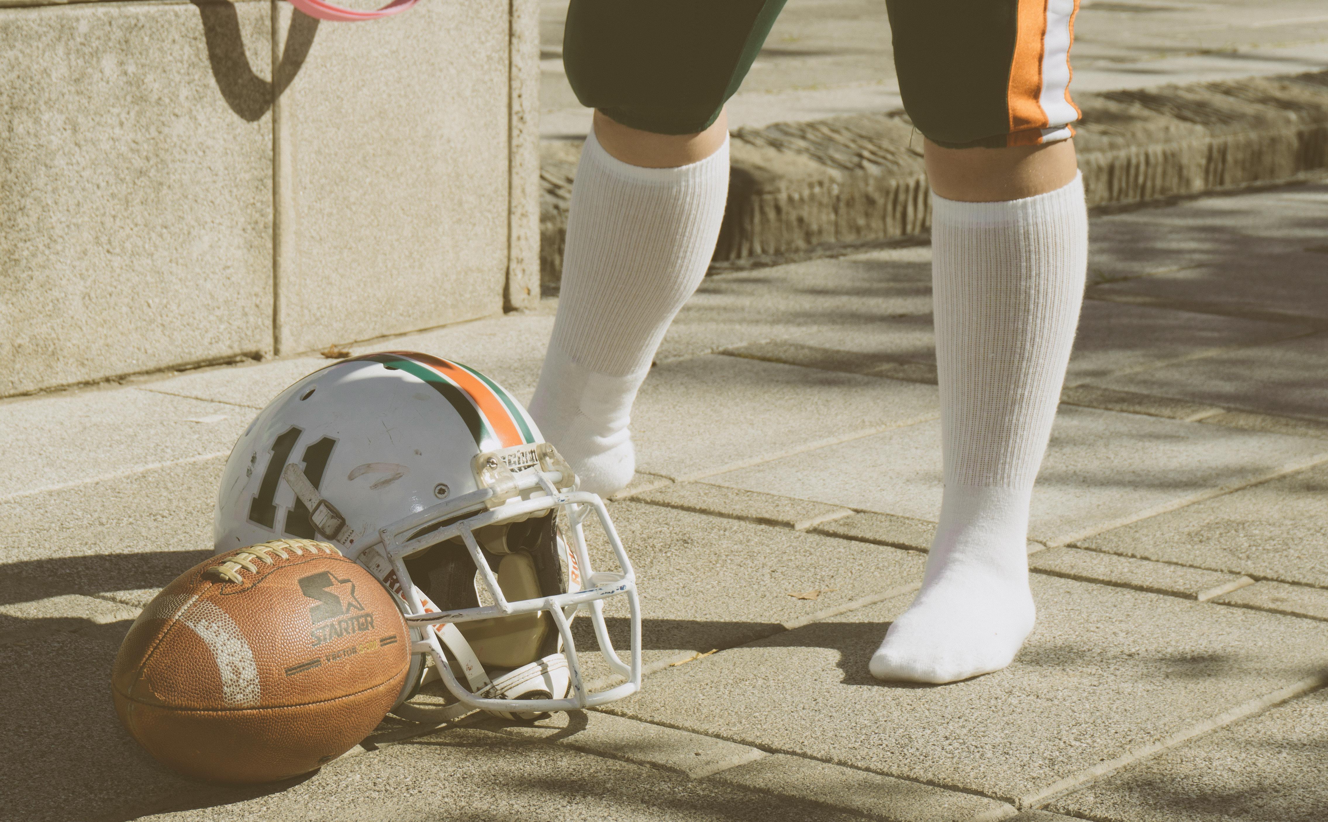 Helmet and Football on the Floor · Free Stock Photo