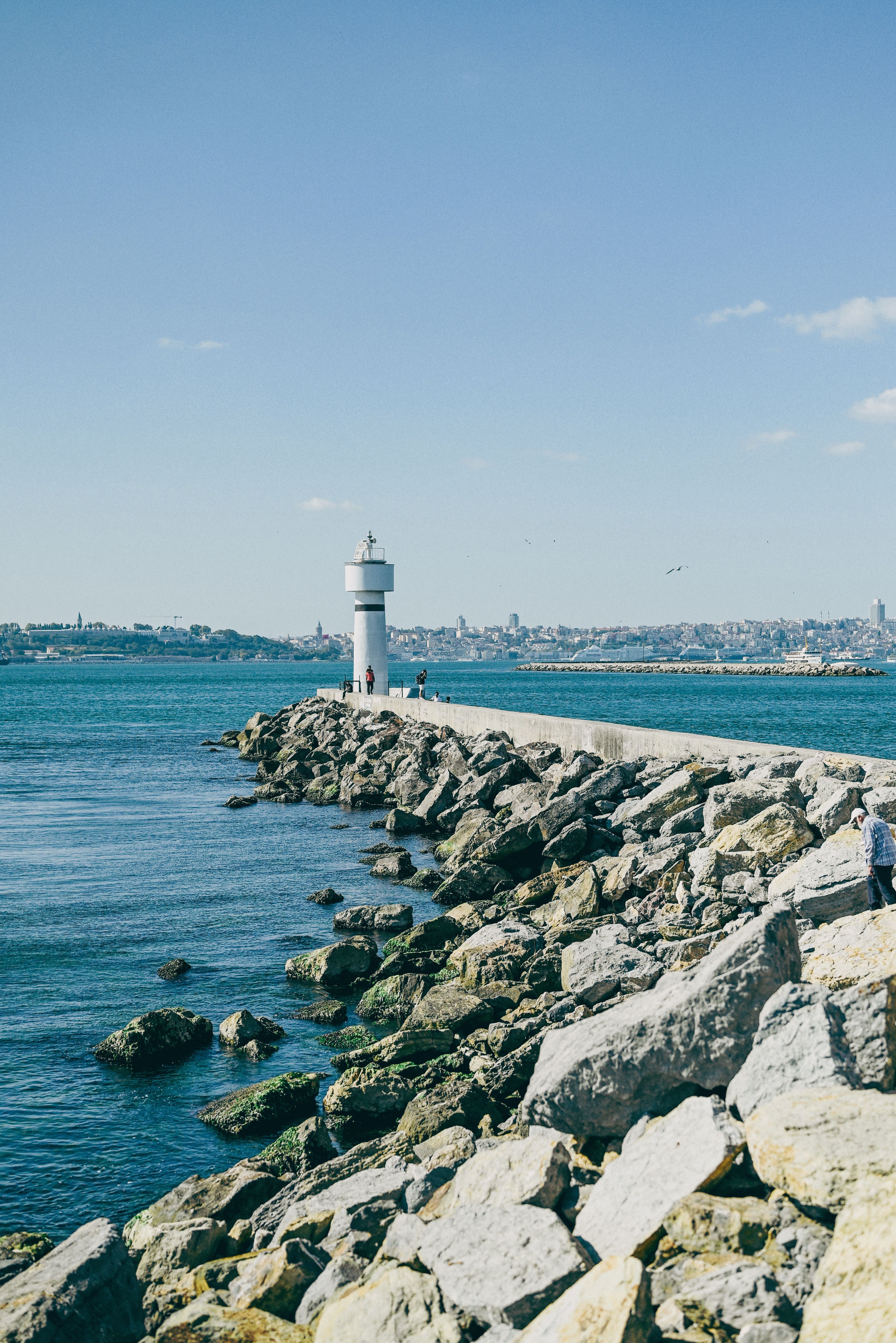 White Lighthouse on the Seawall · Free Stock Photo