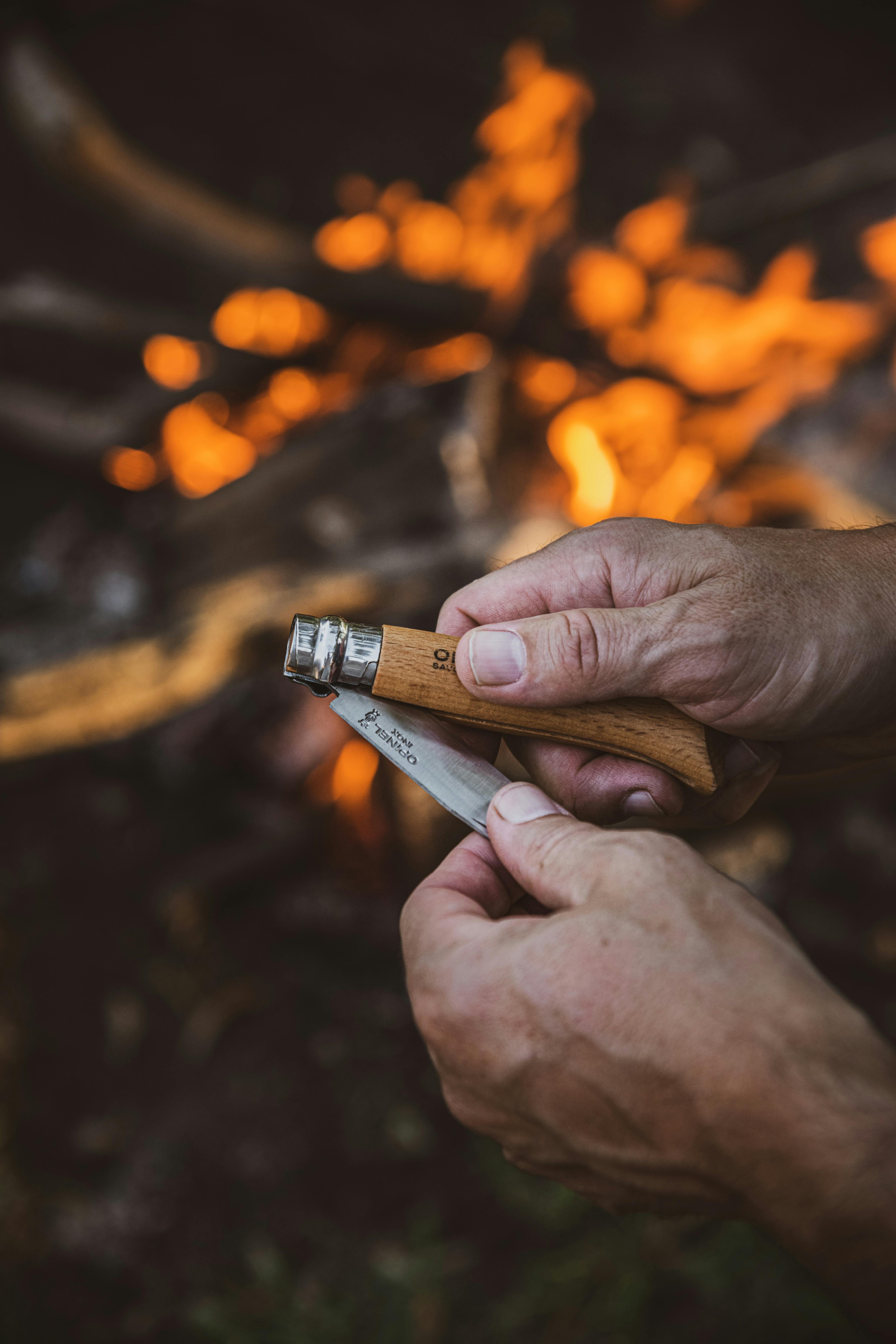 Man Holding a Pocket Knife in his Hands · Free Stock Photo