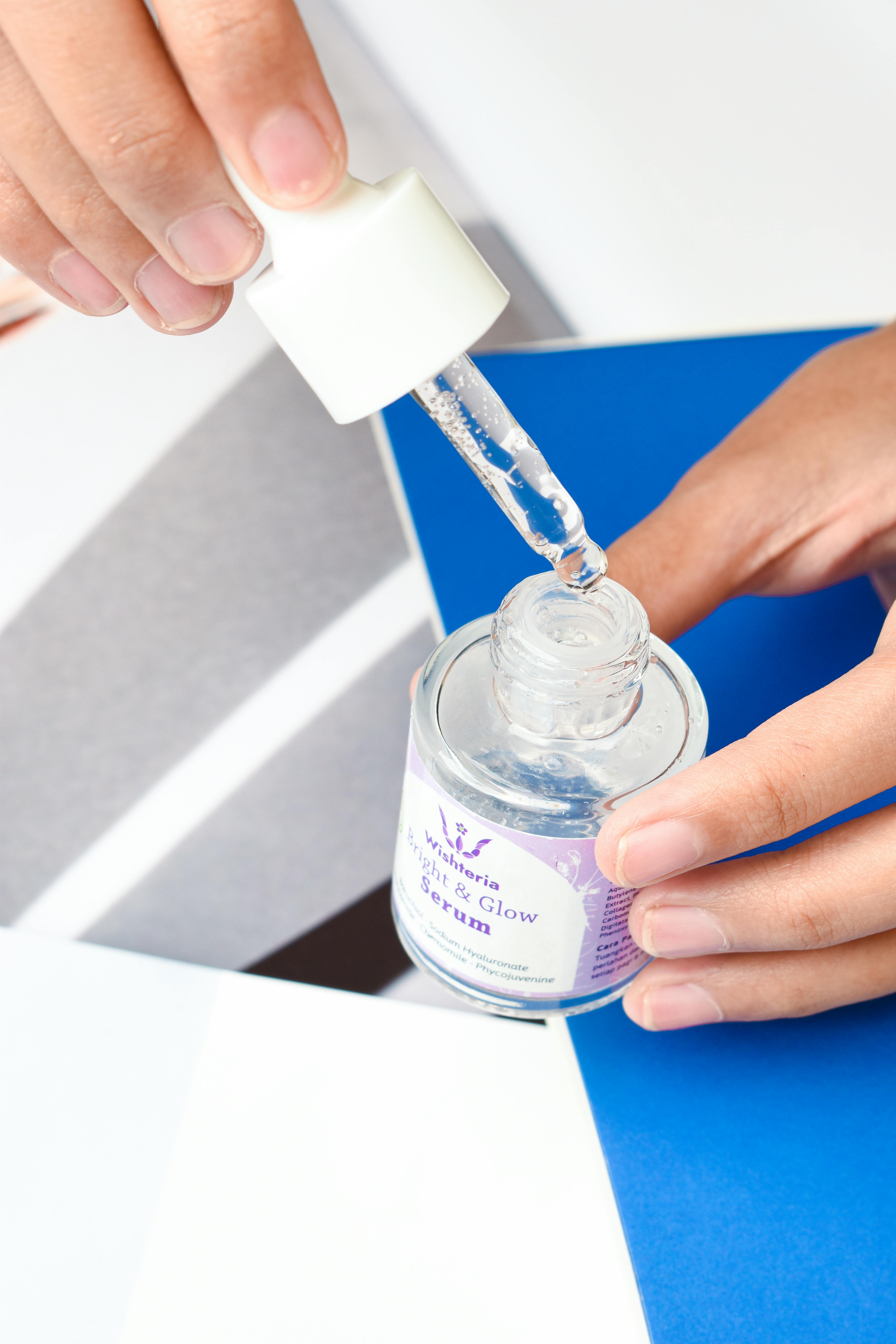 A Person Holding a Dropper Bottle · Free Stock Photo