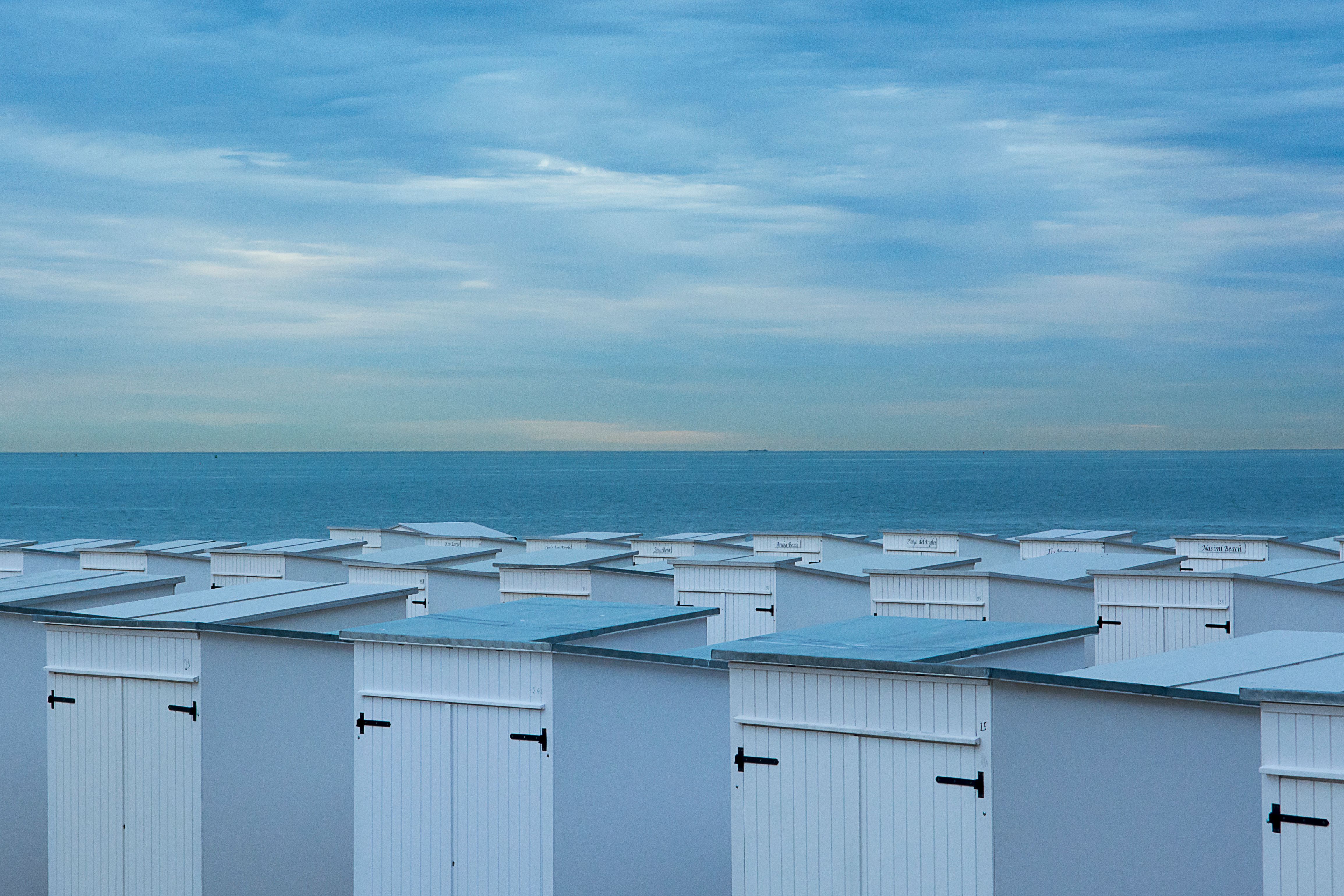 White Wooden Booths on Seashore · Free Stock Photo