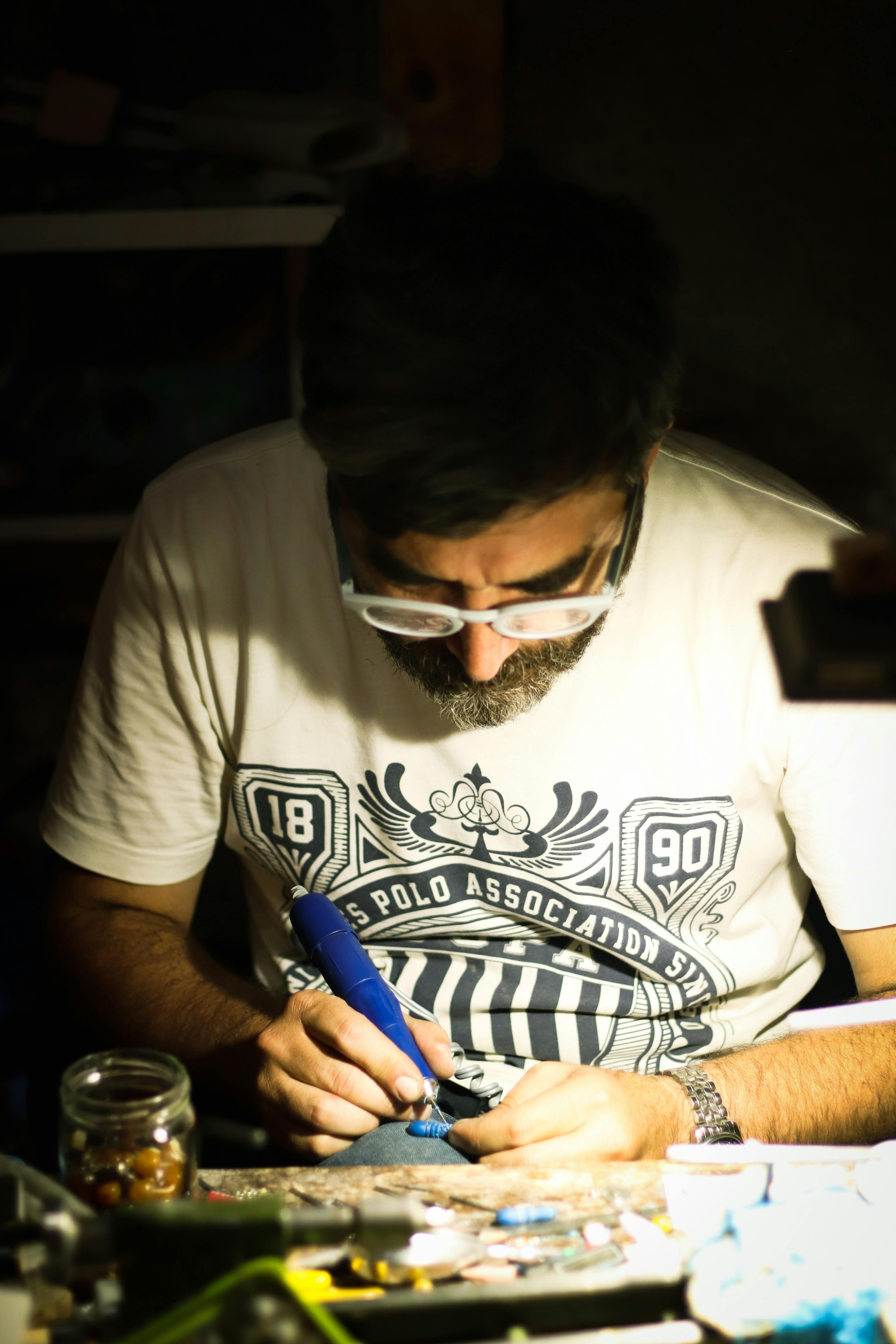 Man Sculpting Tiny Piece of Clay · Free Stock Photo