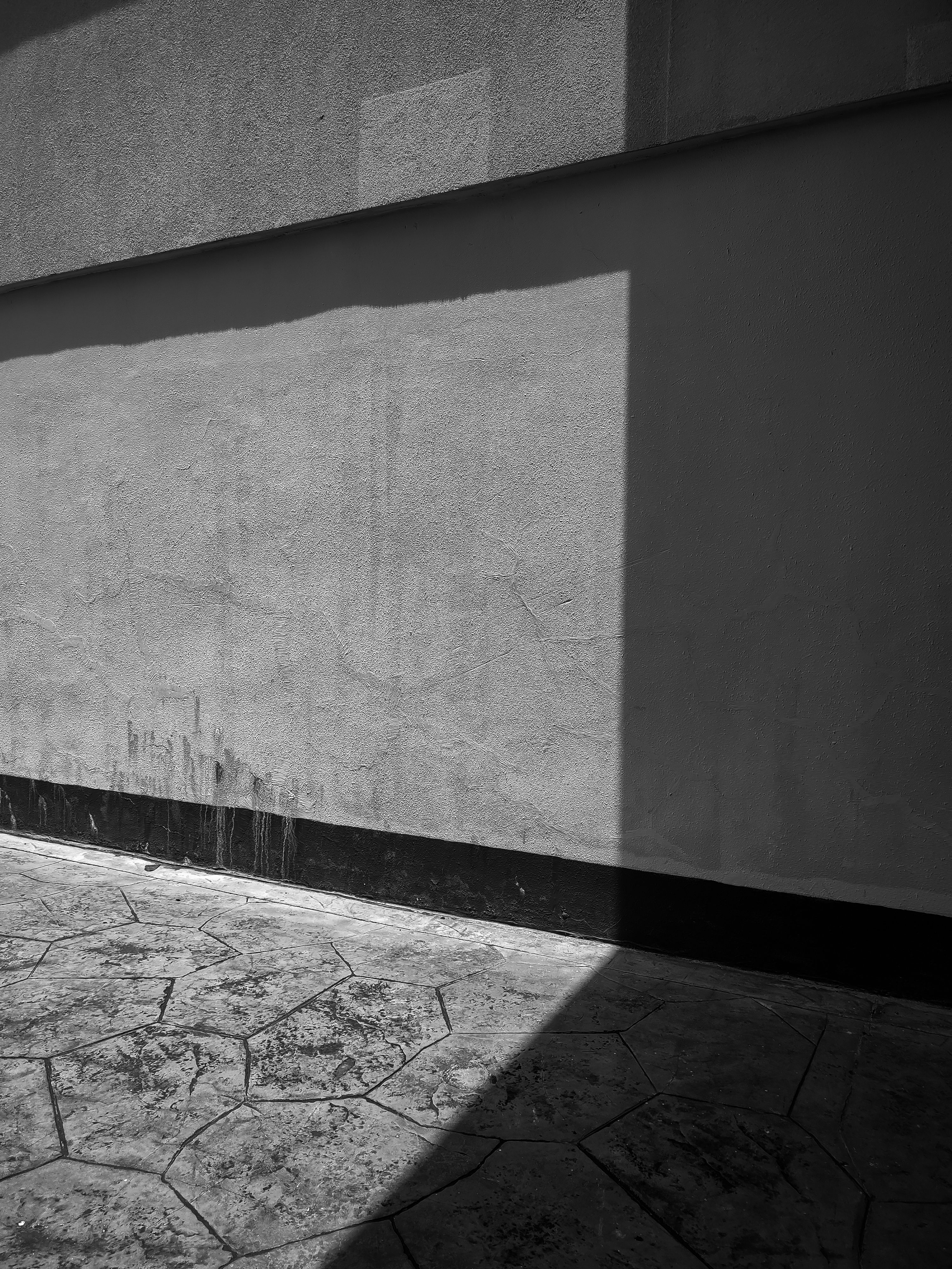 A Grayscale of a Concrete Wall of a Building · Free Stock Photo