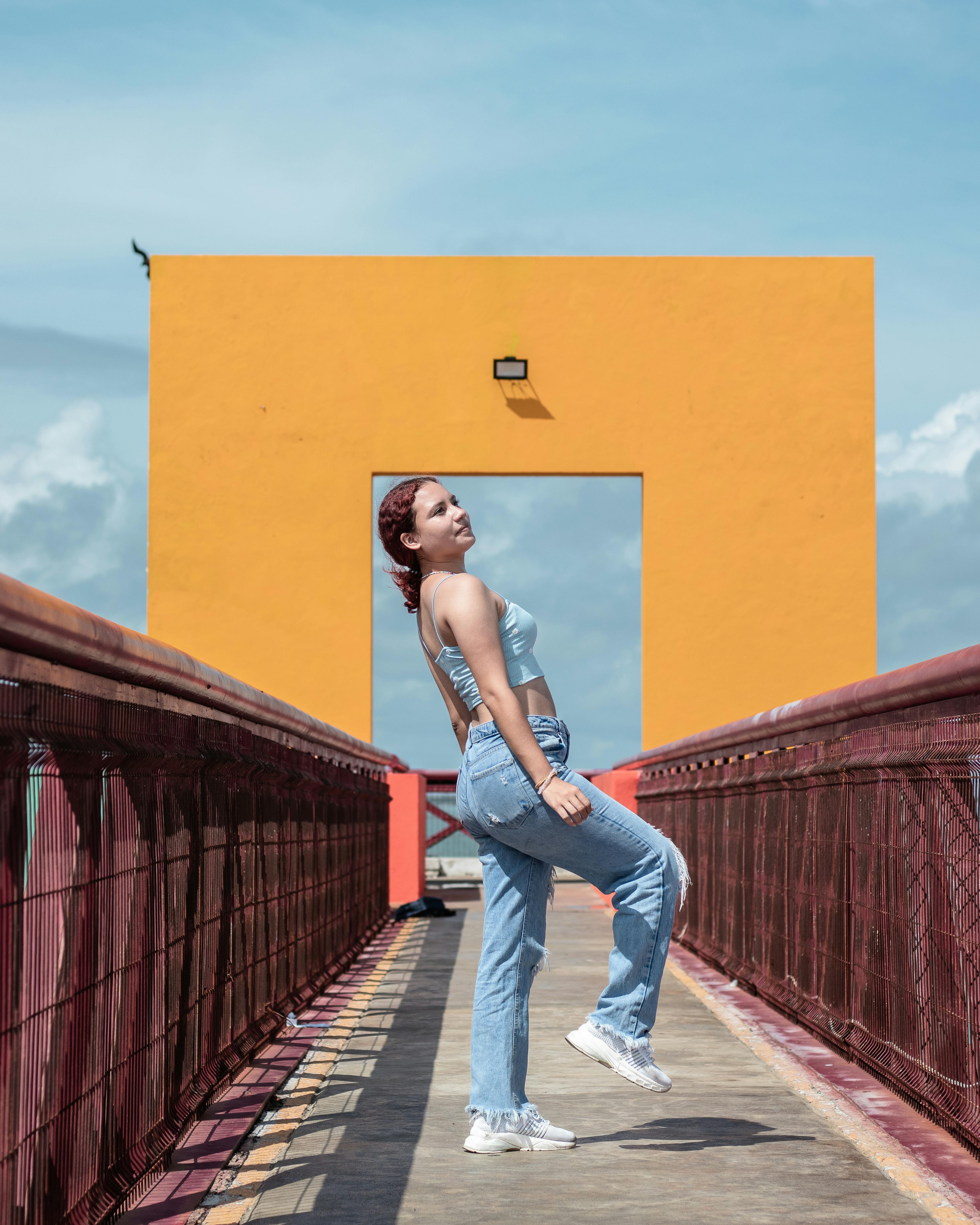 Women Wearing Caps on a Bridge · Free Stock Photo