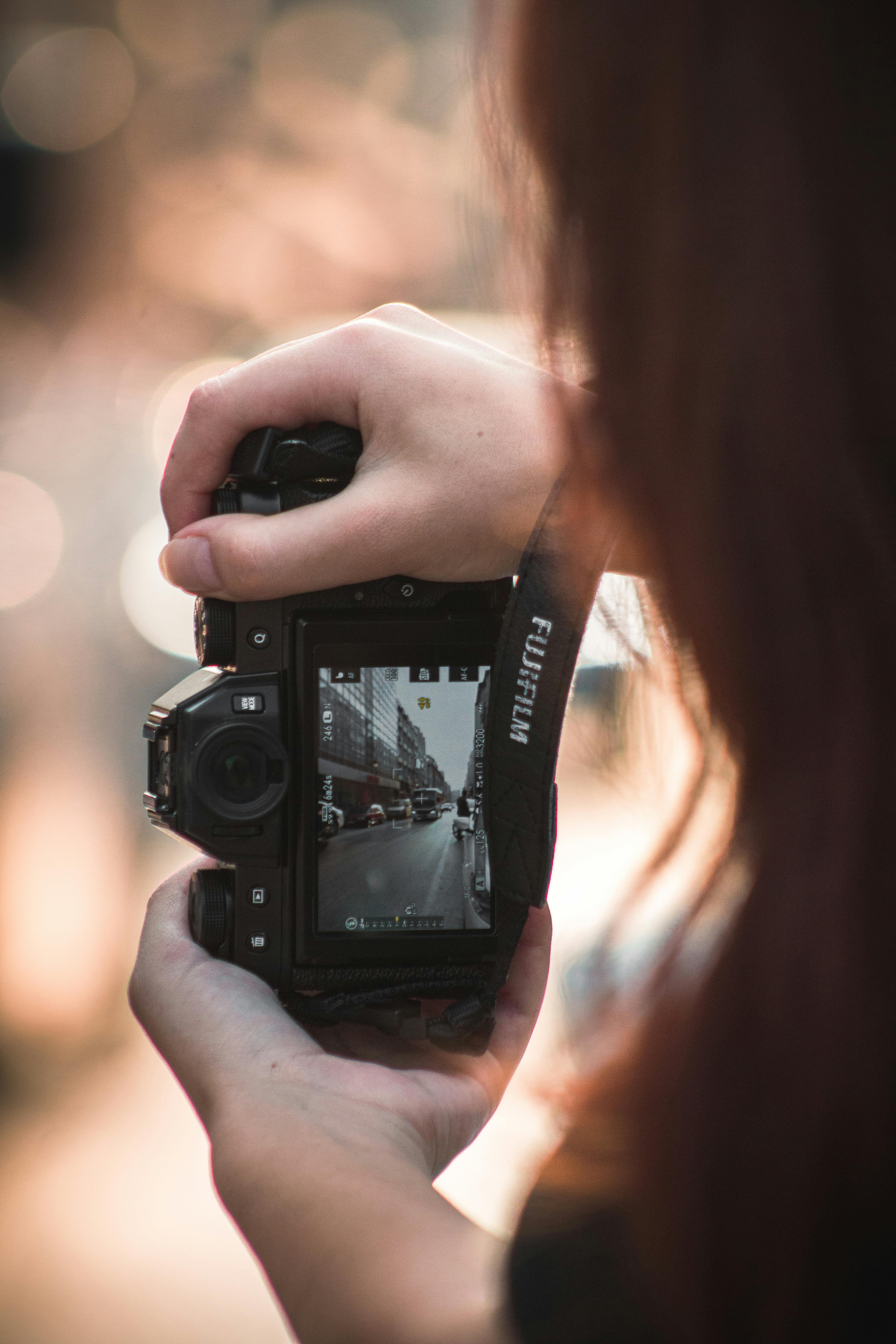 A Person Taking a Picture from a Camera · Free Stock Photo