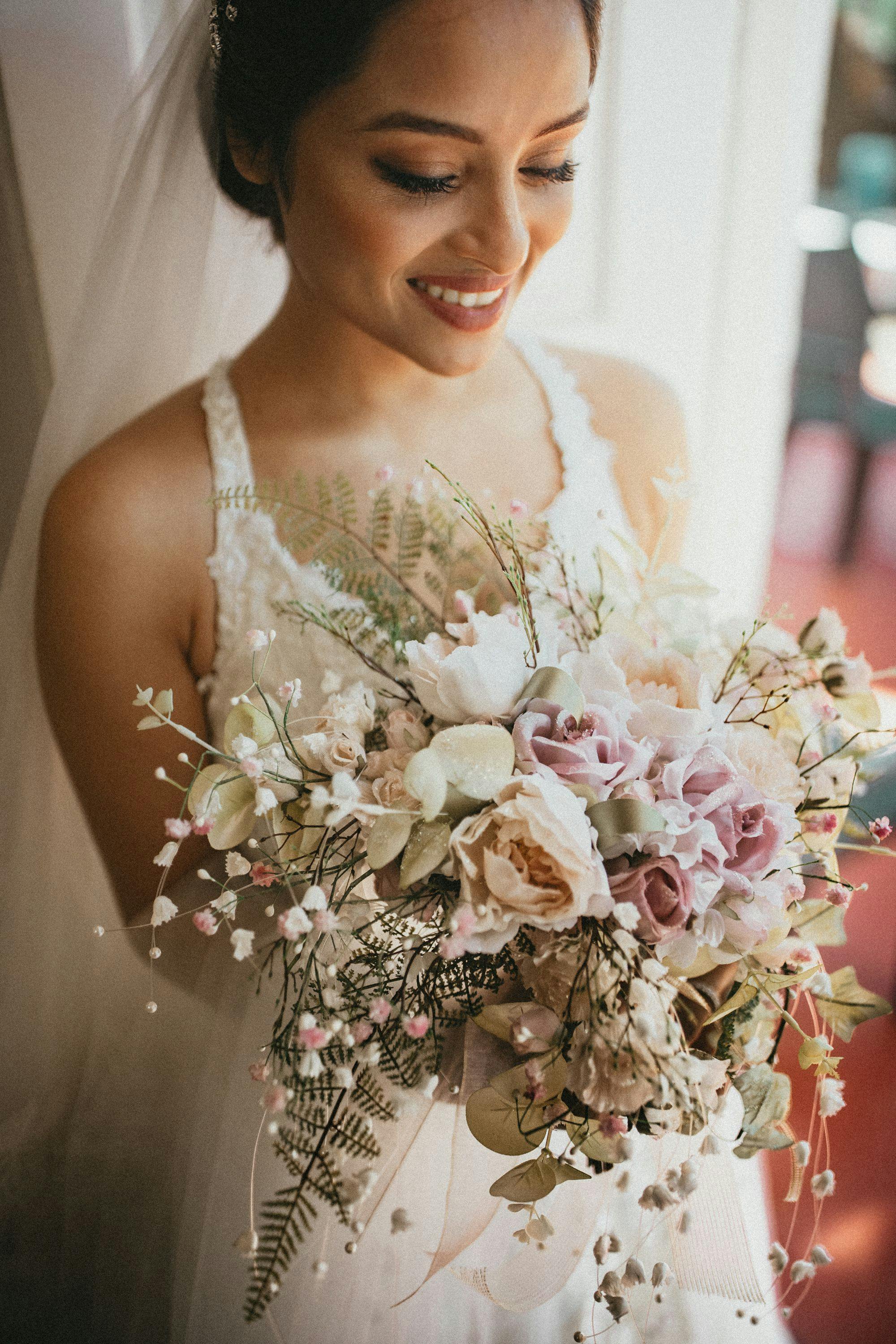 Bride Posing with a Flower Bouquet · Free Stock Photo