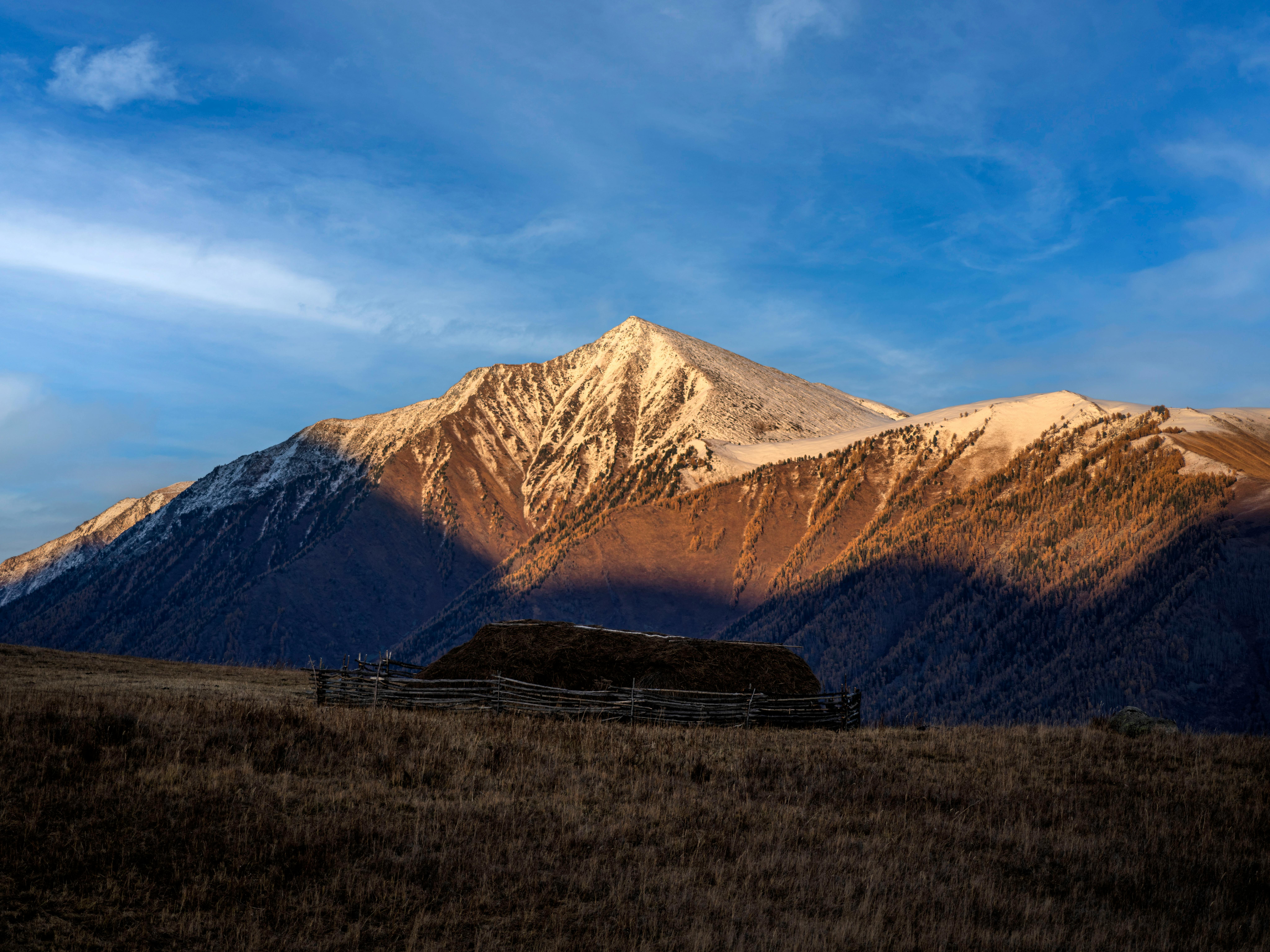 Haystack Near Snow Capped Mountain · Free Stock Photo