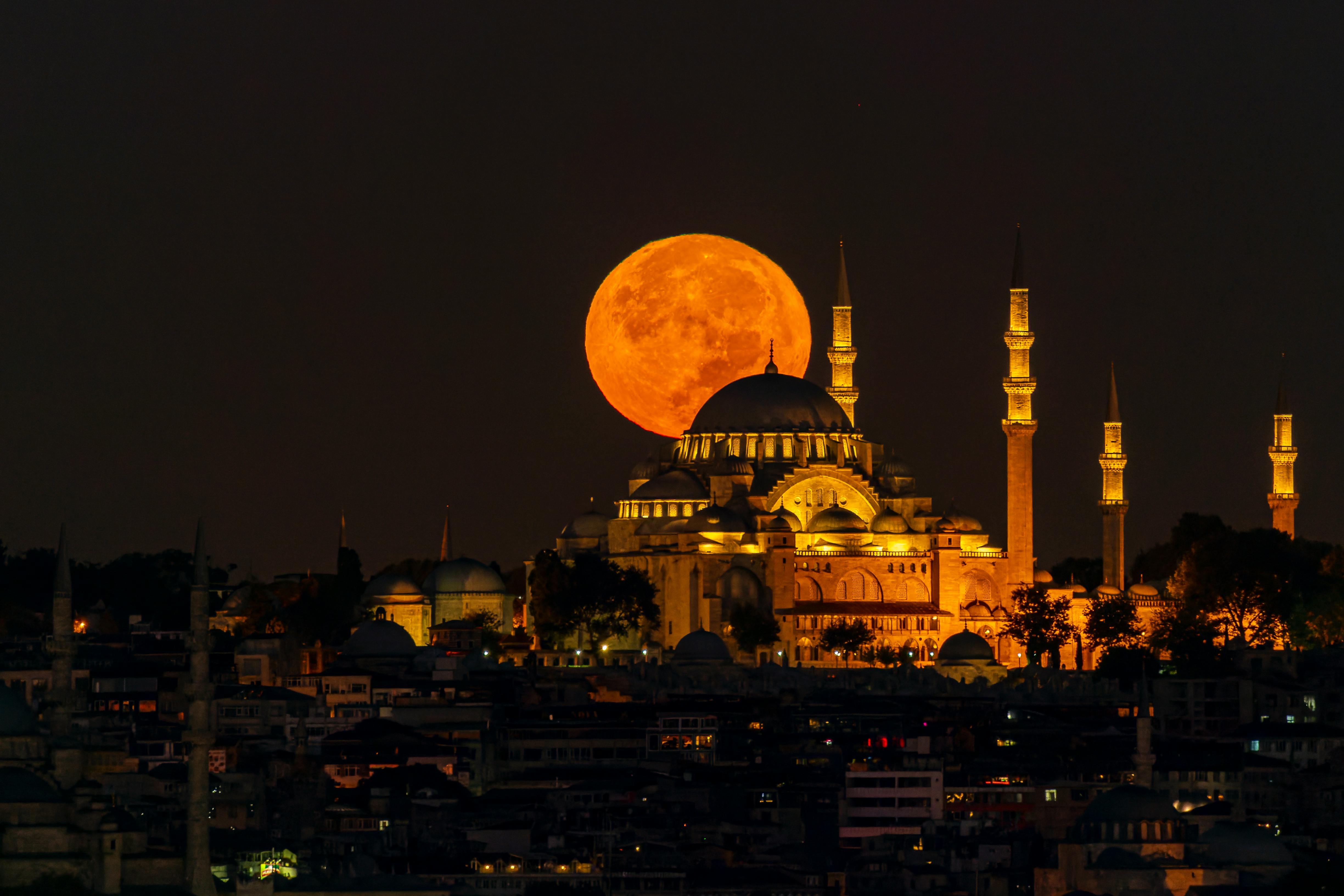 Reflection of Yellow High Rise Tower during Night Time · Free Stock Photo