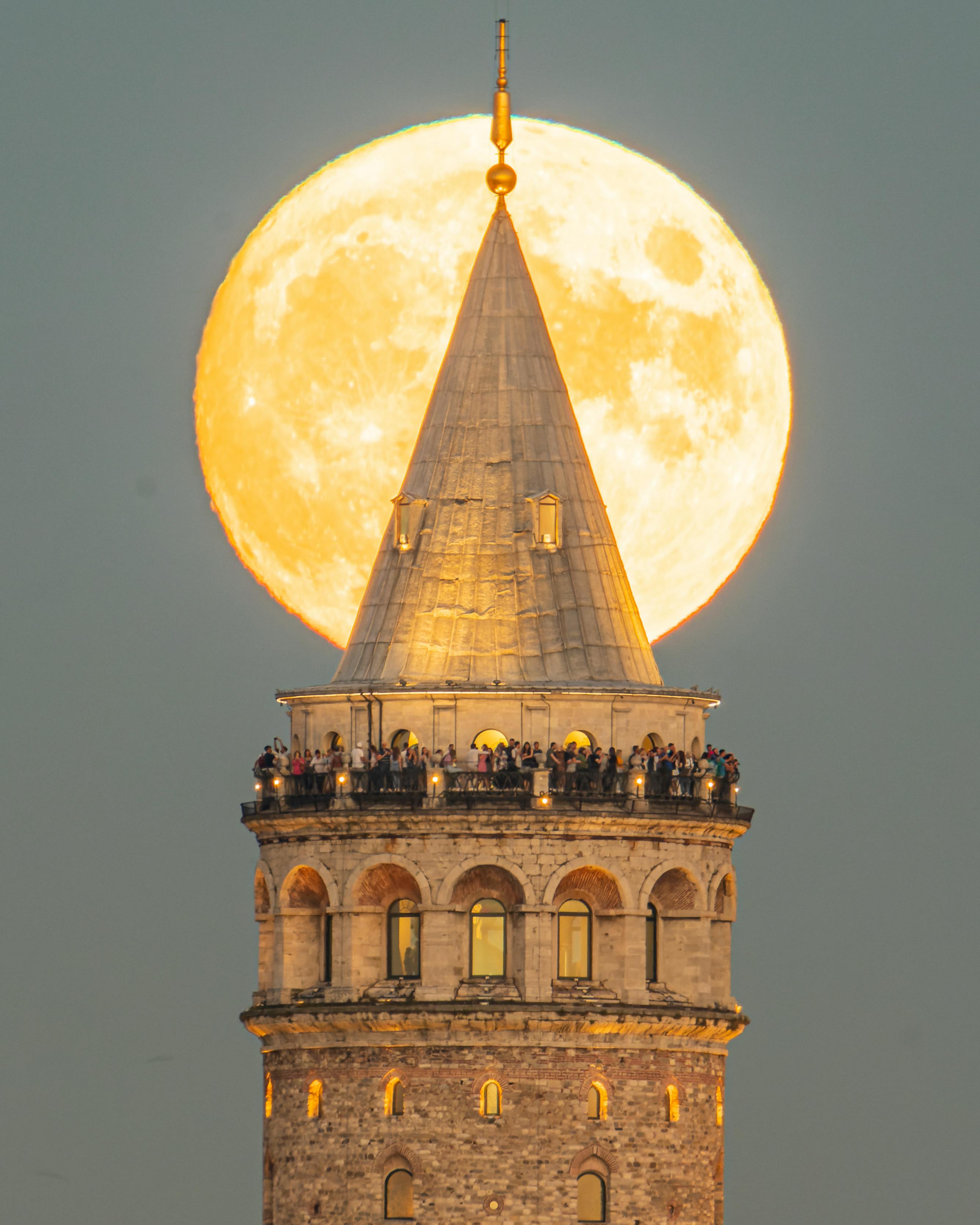The Moon Behind a Tower · Free Stock Photo