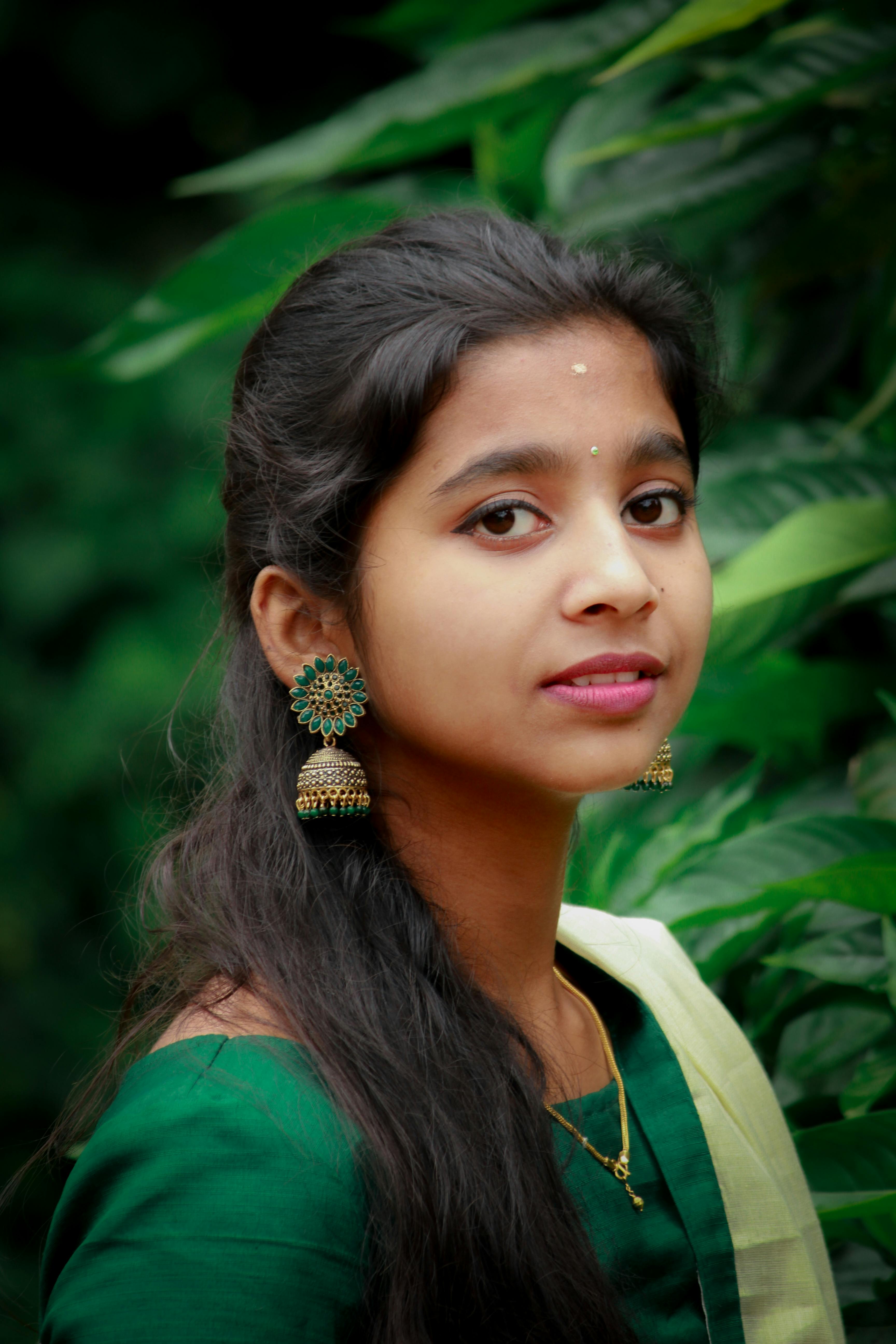 Close-Up Shot of a Woman in Green Traditional Clothing · Free Stock Photo