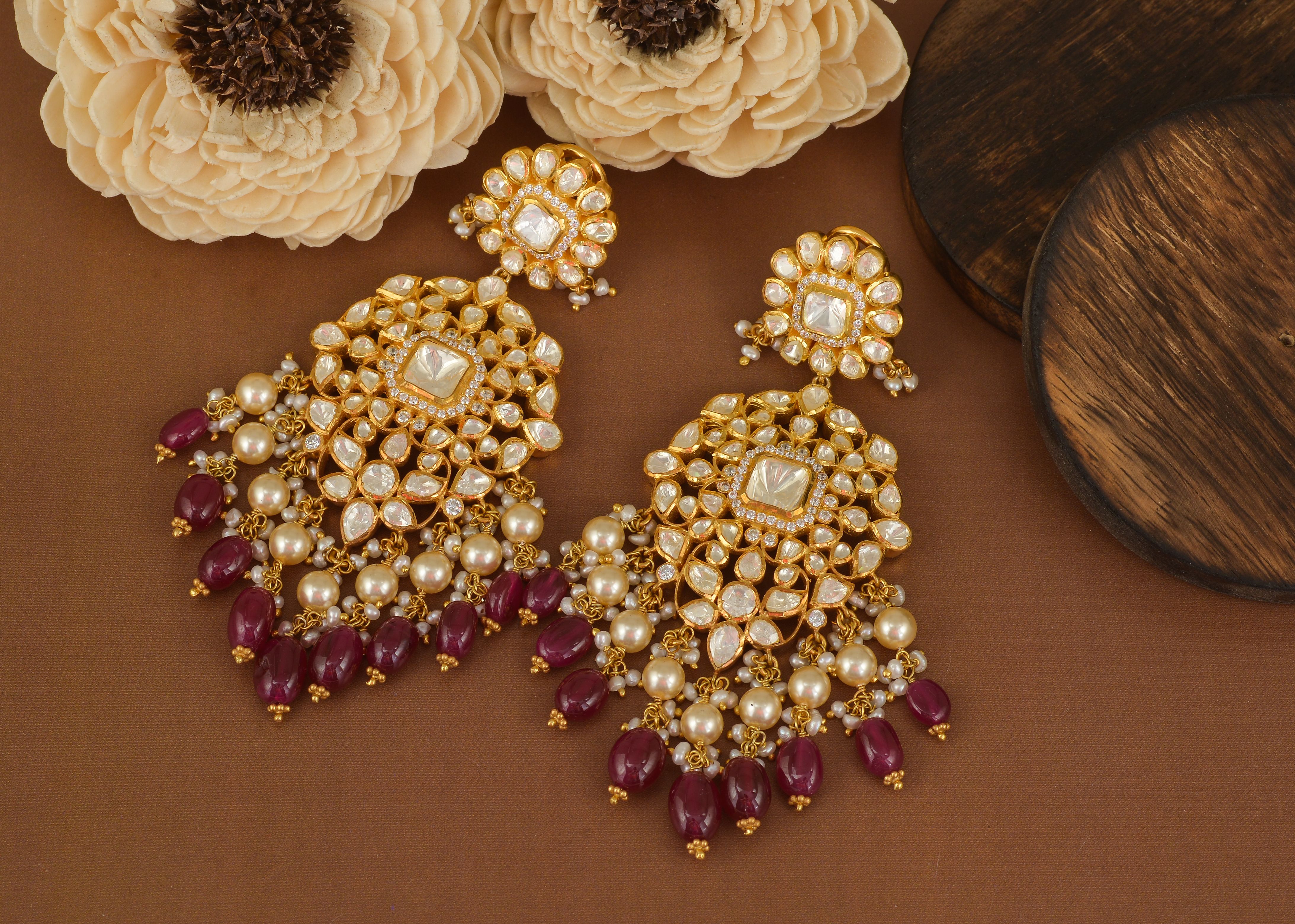 Close-Up Shot of Beaded Earrings on Brown Surface · Free Stock Photo
