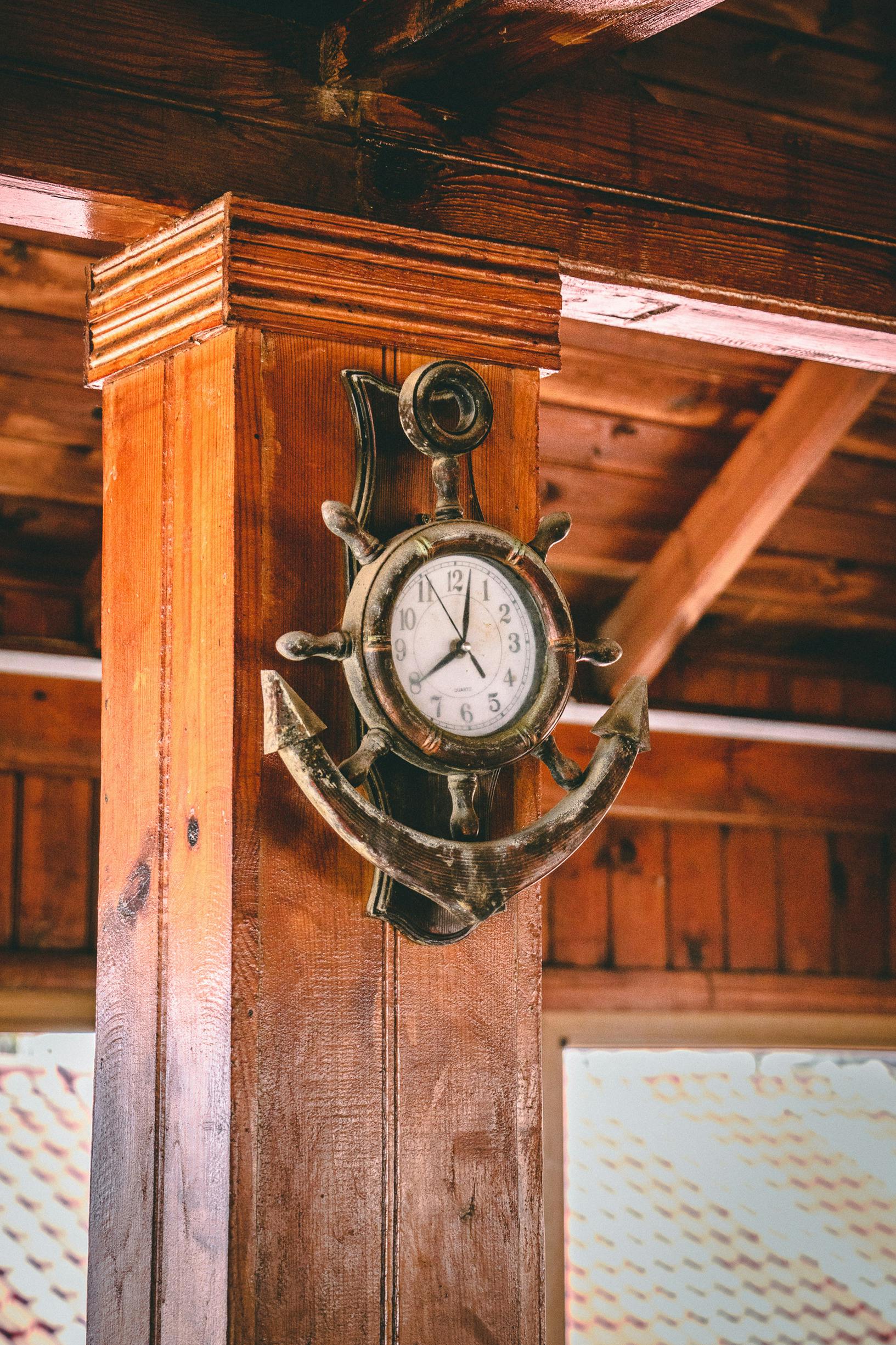 Clock Hanging on a Wooden Pillar · Free Stock Photo