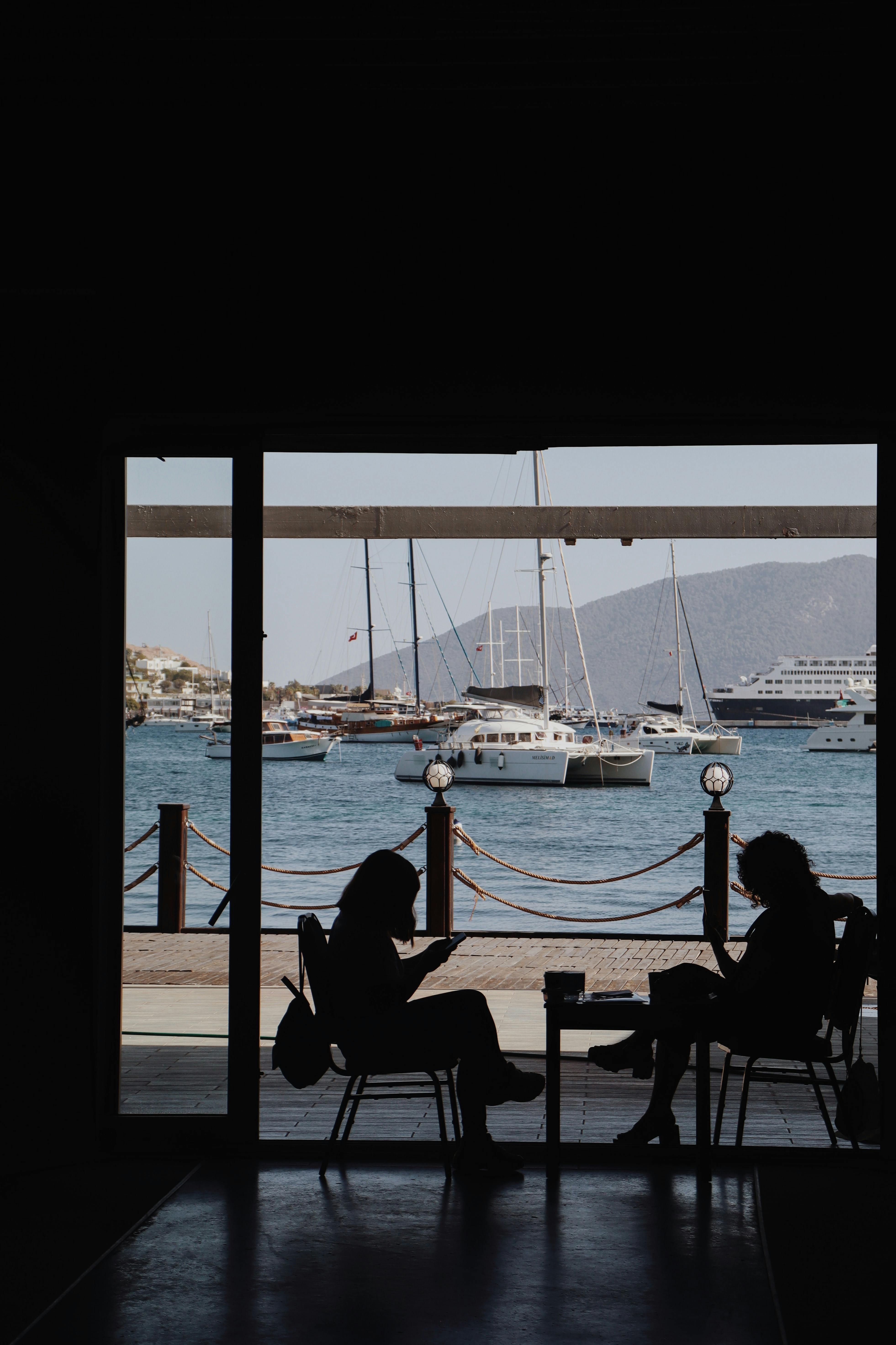 People Sitting in Shadow near Water in Town · Free Stock Photo