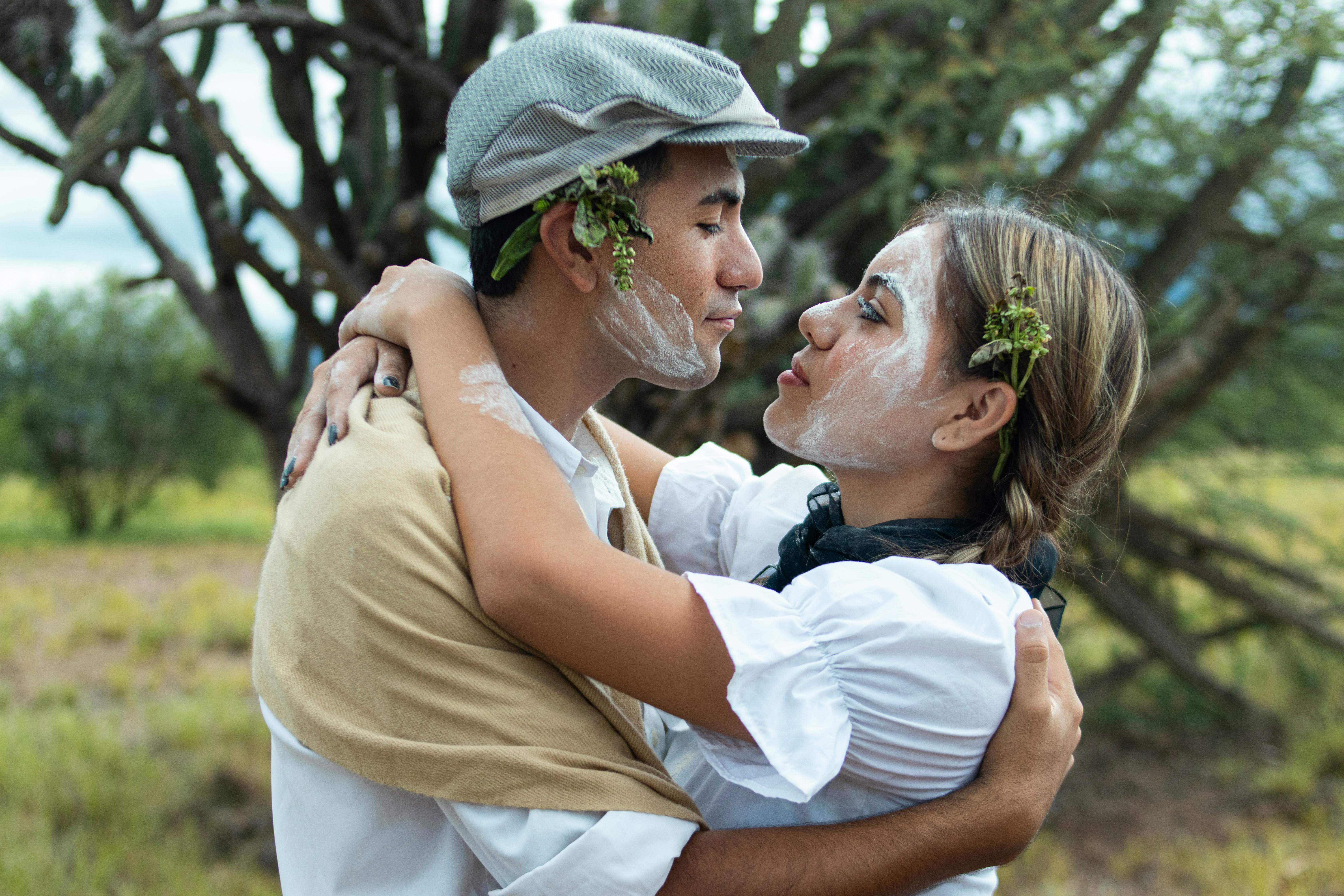 Young Couple with Powdered Faces Standing Face to Face and Embracing ...