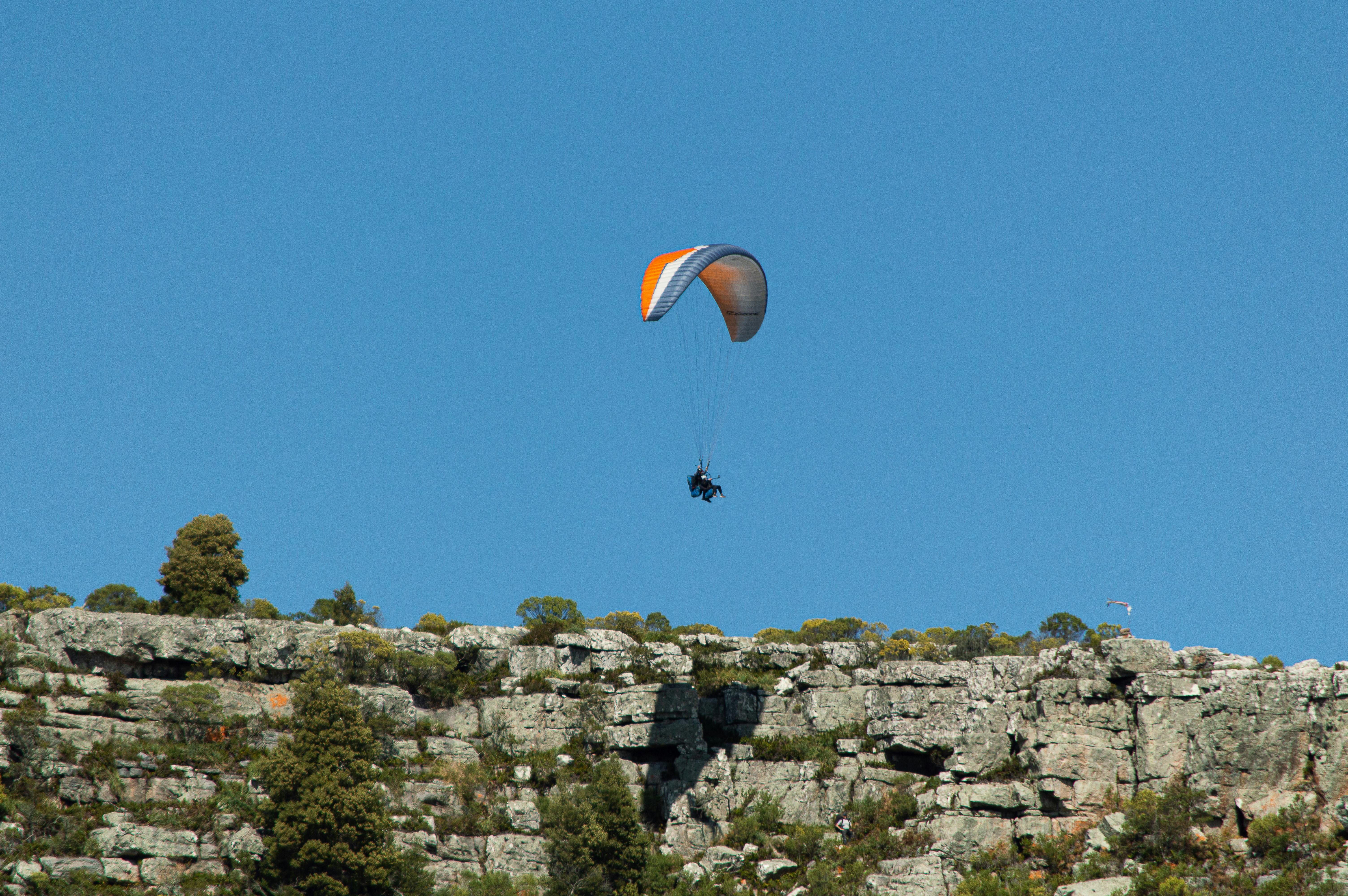 Parachuting over Rocks · Free Stock Photo