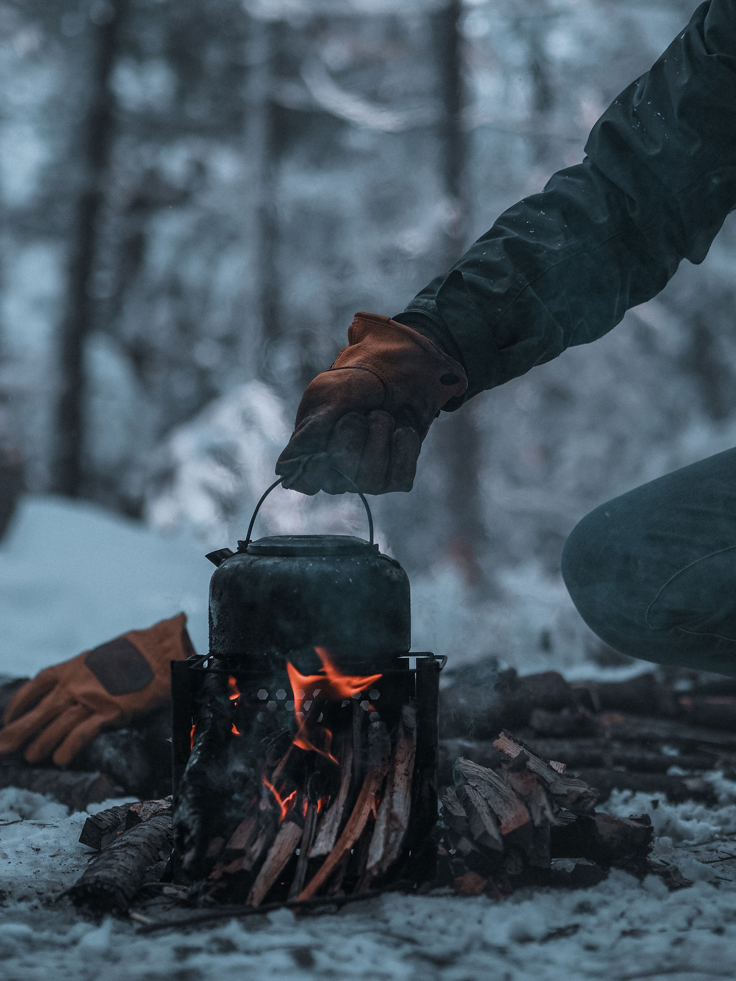 Hand in Glove Holding Kettle over Bonfire in Winter · Free Stock Photo