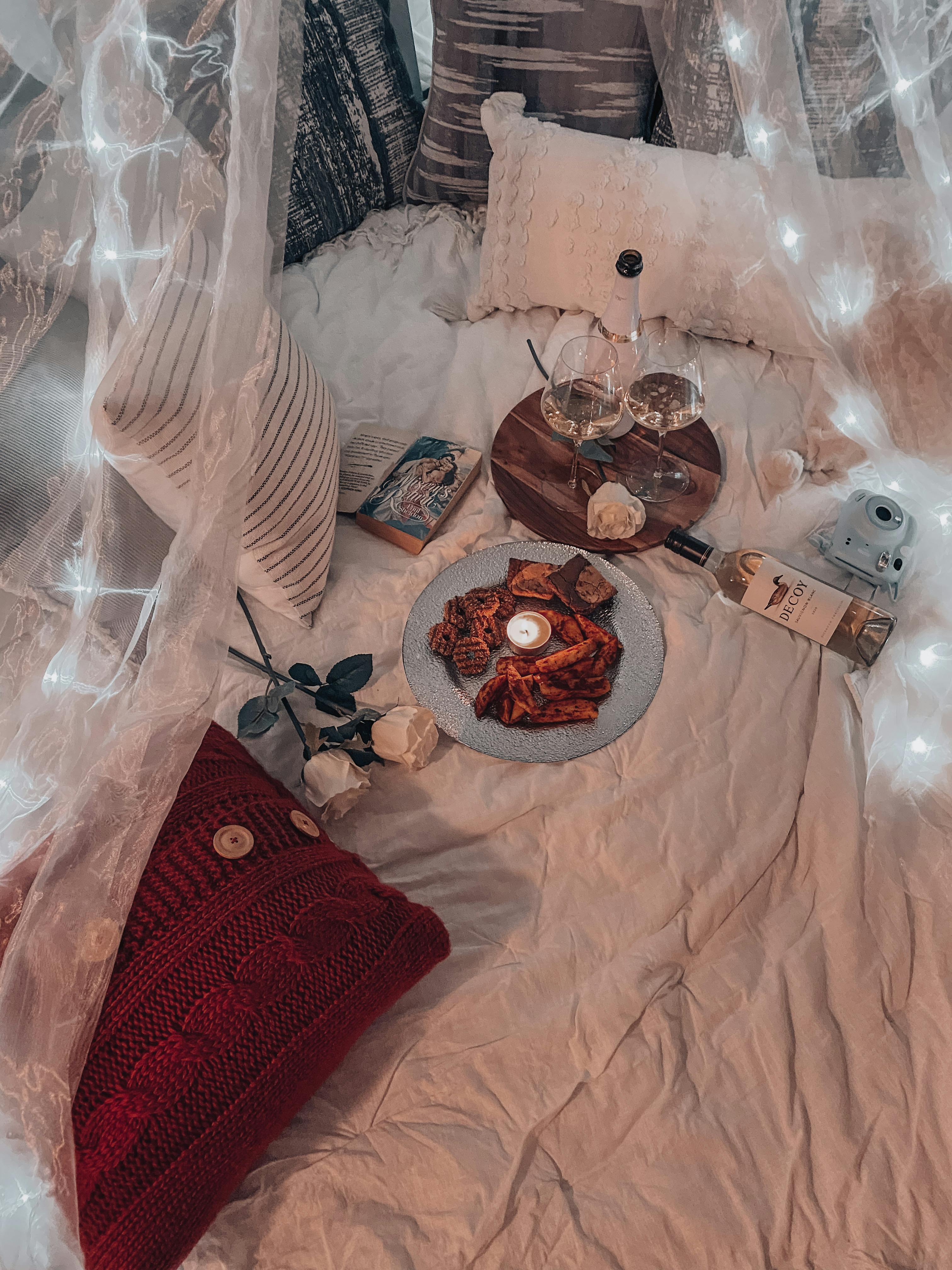 Wine and Food on a Bed · Free Stock Photo