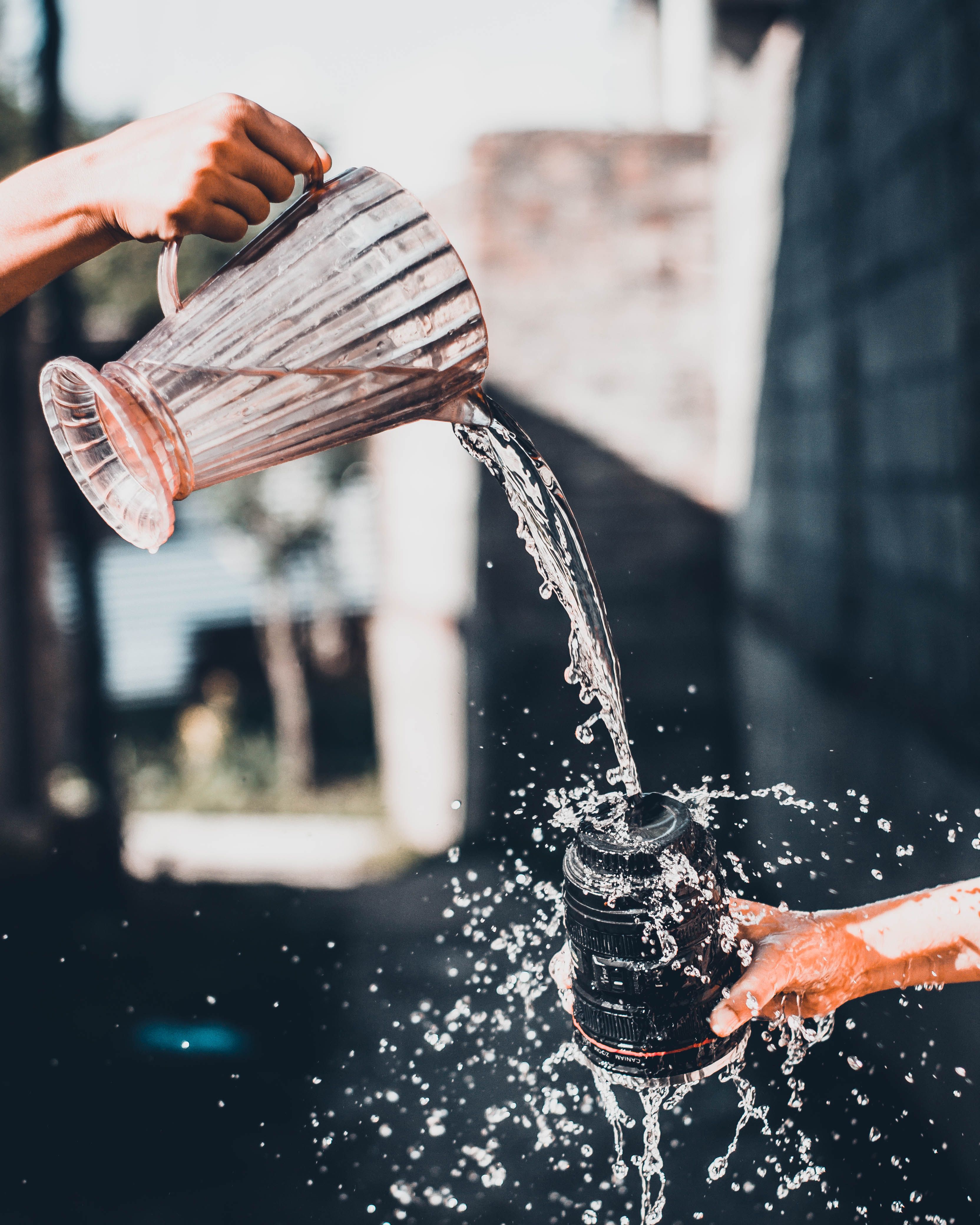 Pouring Water to Camera Lens · Free Stock Photo