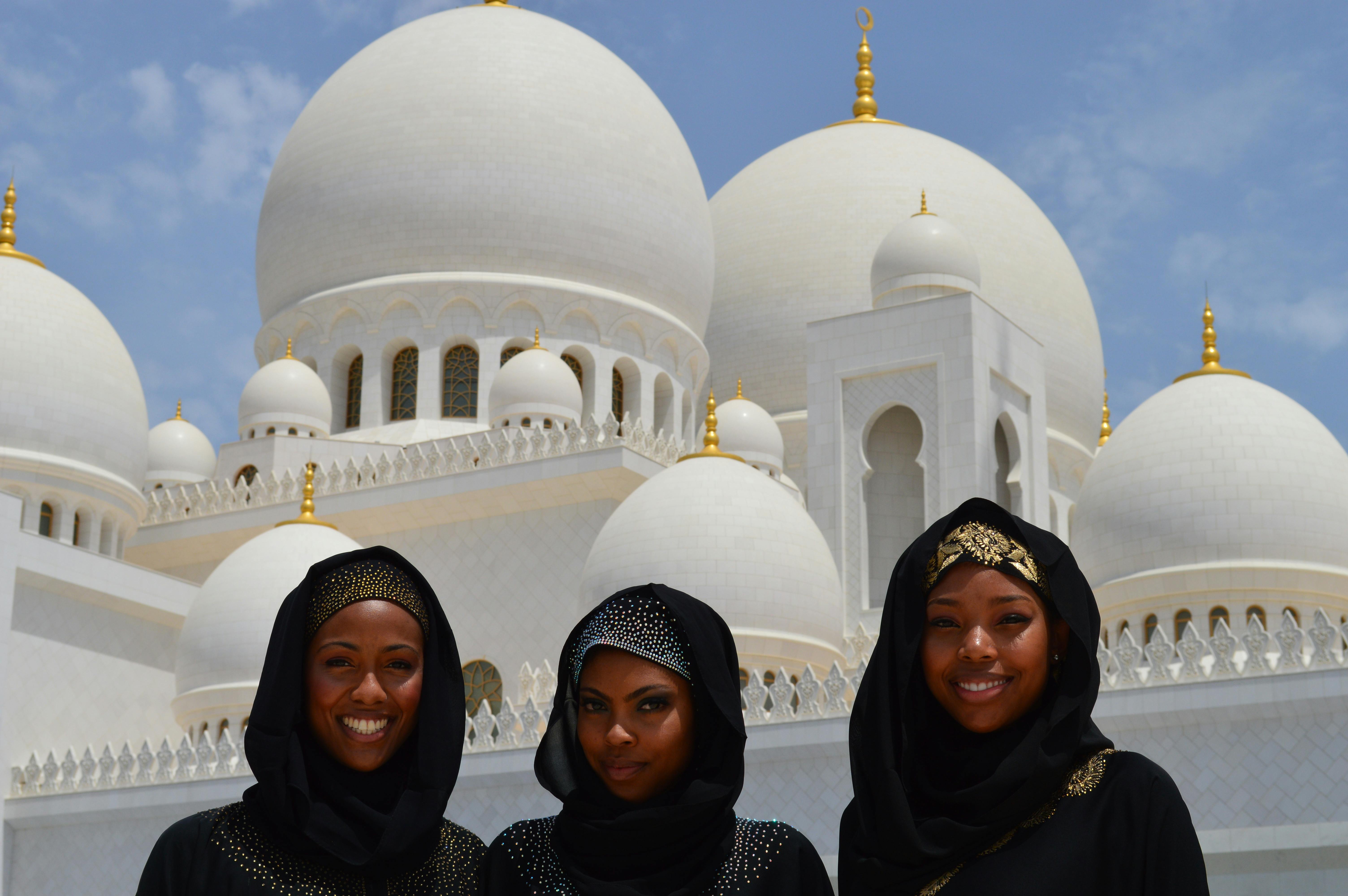 Three Women Taking A Photo In Front Of White Mosque · Free Stock Photo