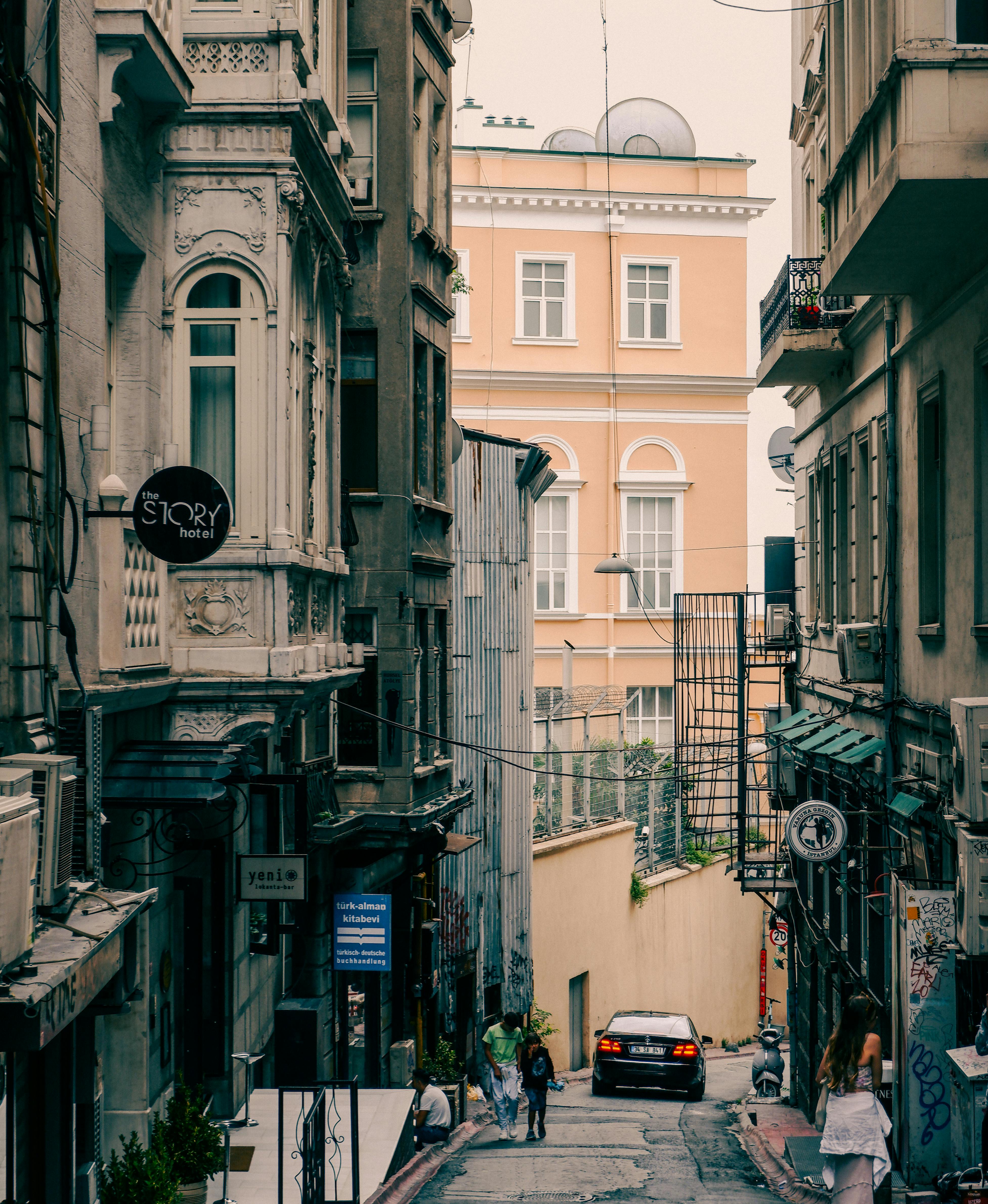 Photo of a Black Car Between Buildings · Free Stock Photo