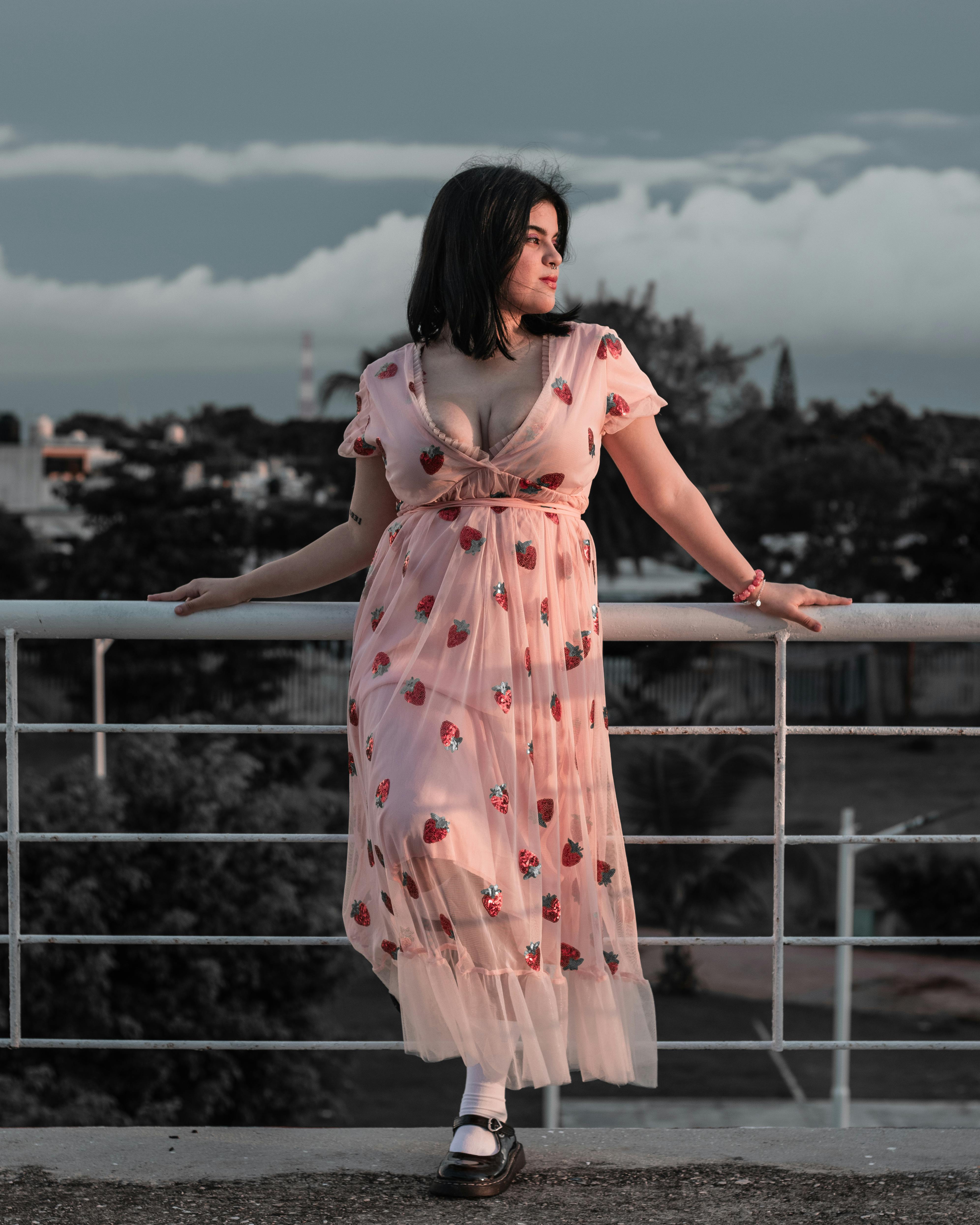 Woman in Pink Dress Leaning on Railing · Free Stock Photo