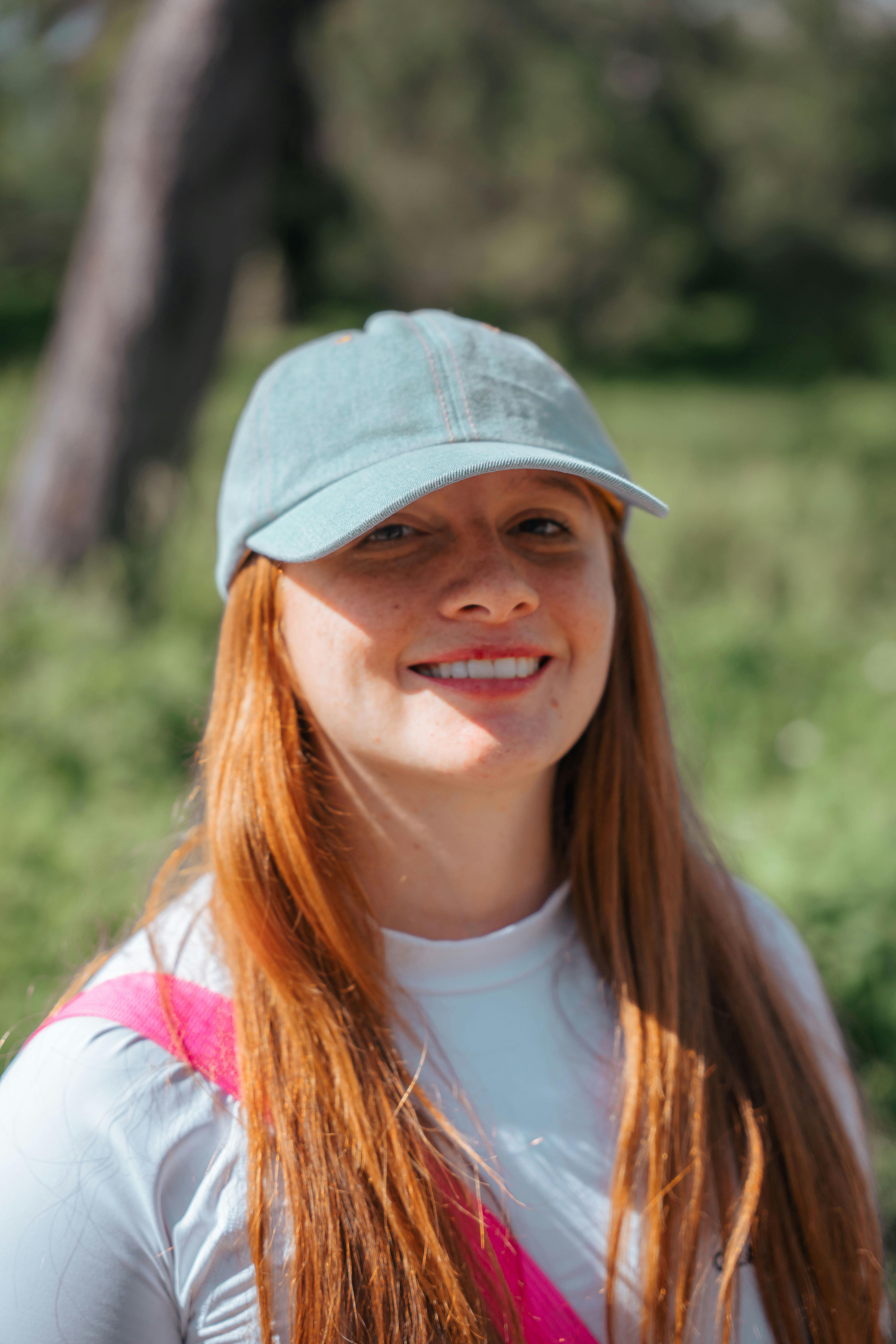 Portrait of a Pretty Woman Wearing White Cap · Free Stock Photo