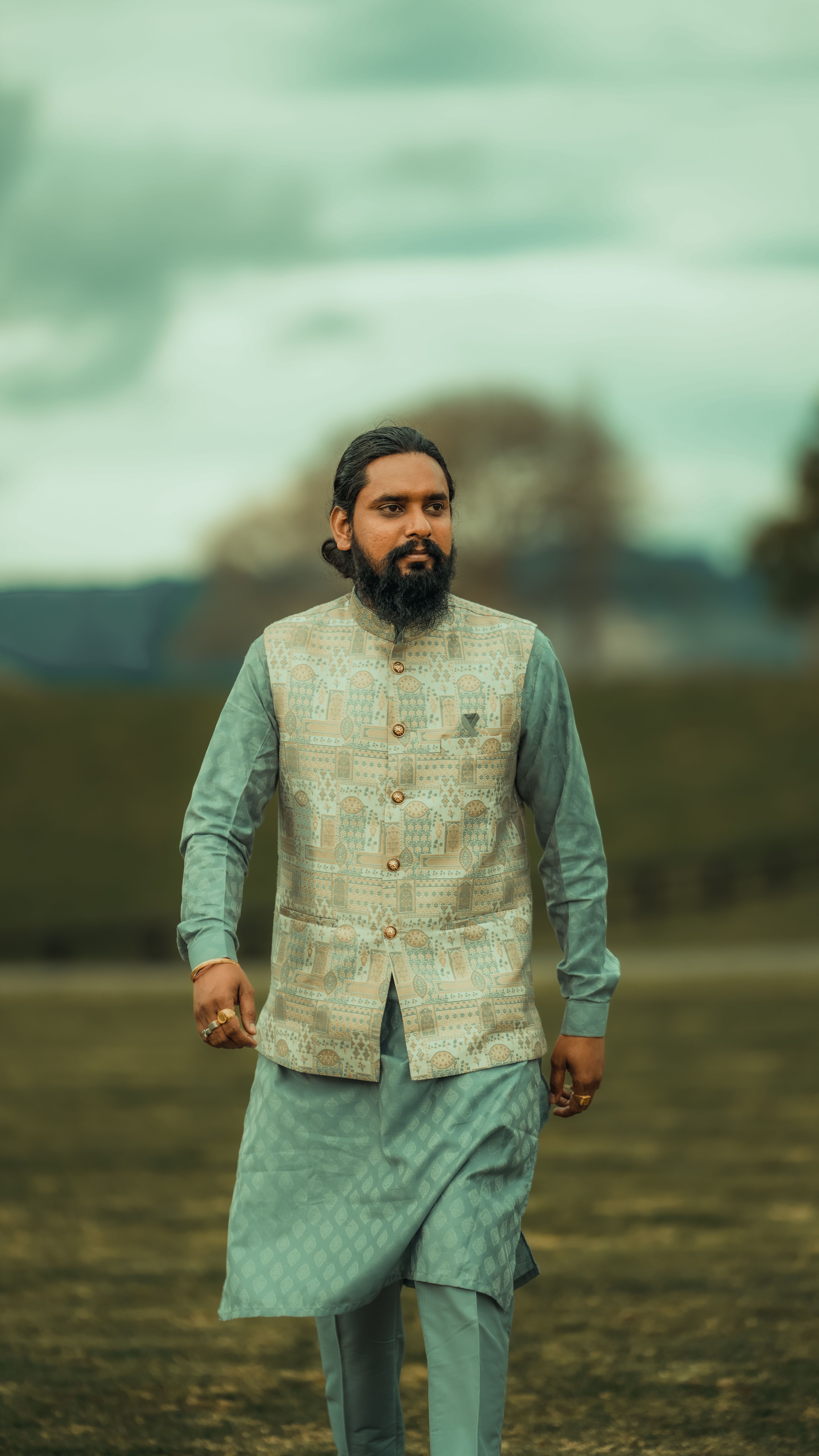 A Man Wearing a Gray Sherwani Walking · Free Stock Photo